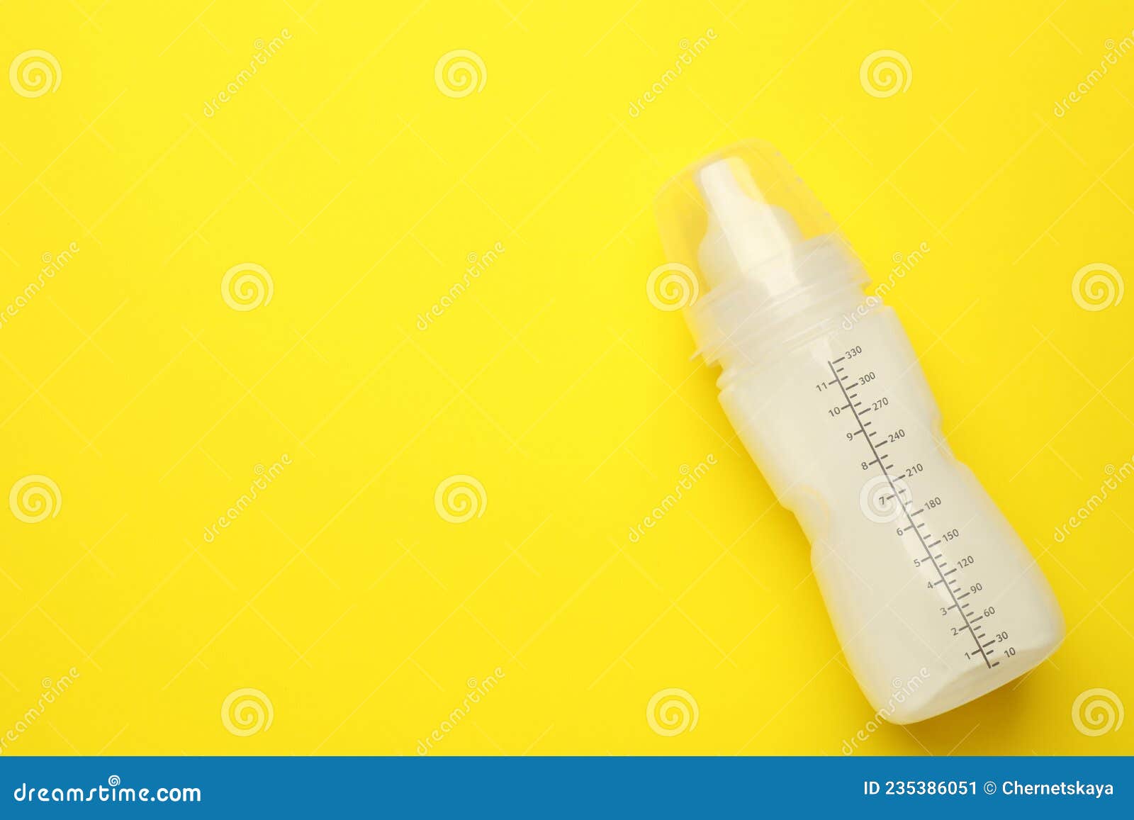 Feeding Bottle with Infant Formula on Yellow Background, Top View ...