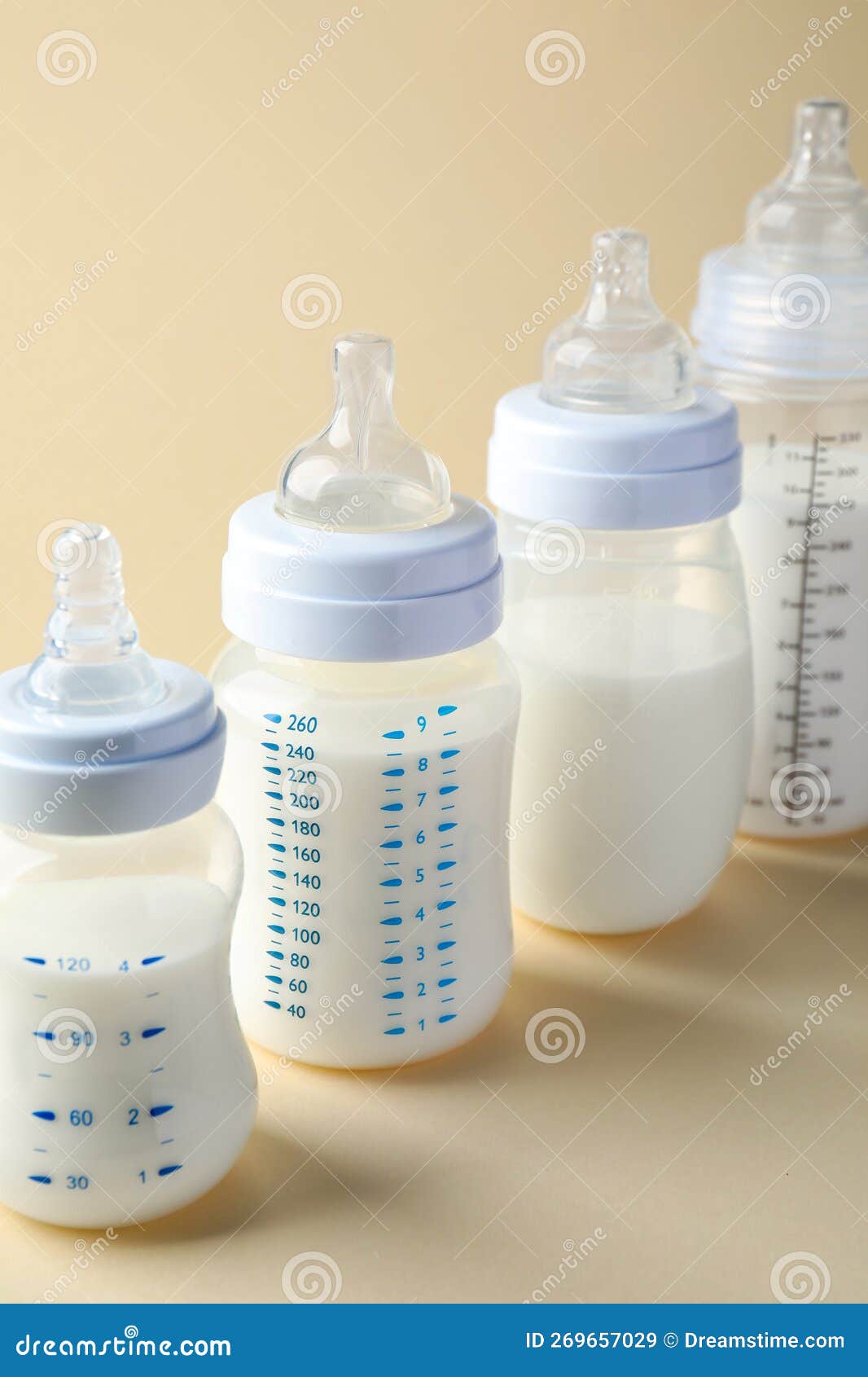Feeding Bottles with Baby Formula on Beige Background Stock Image ...