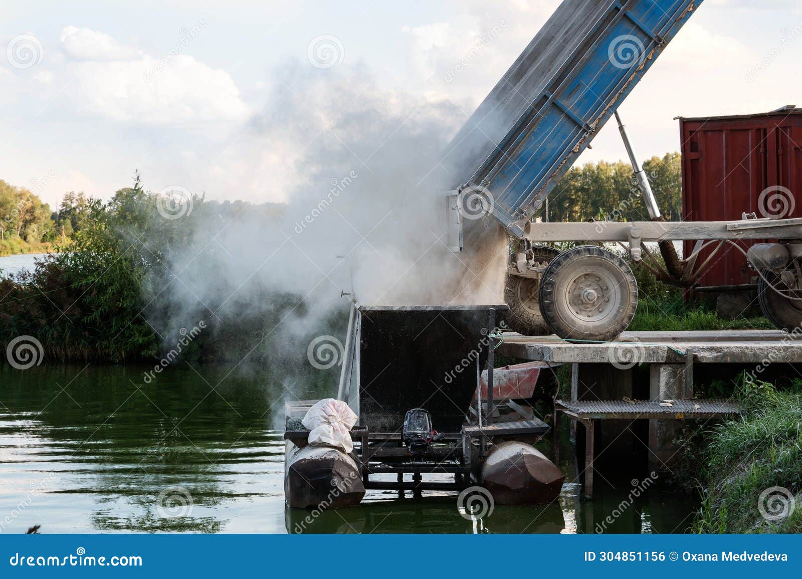 Feeding Fish in a Fish Farm. Loading Fish Feed into the Boat from the ...
