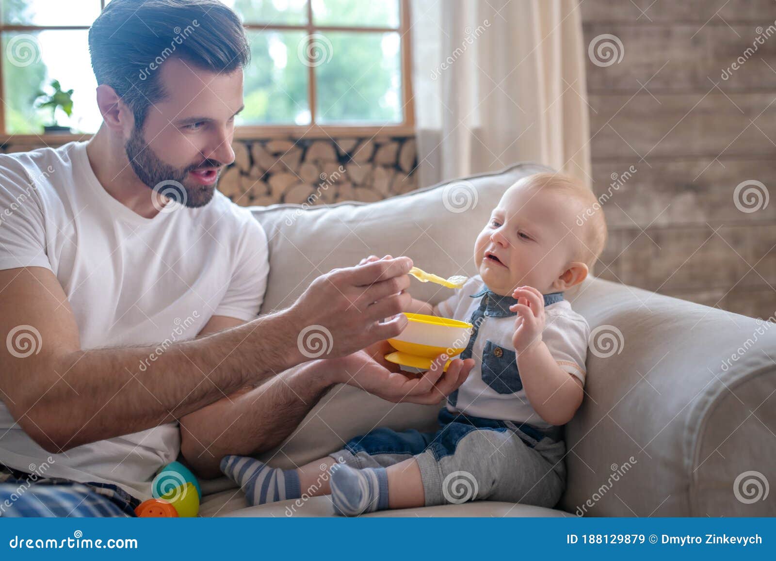 Young Father Feeding the Baby and Smiling Stock Image - Image of ...
