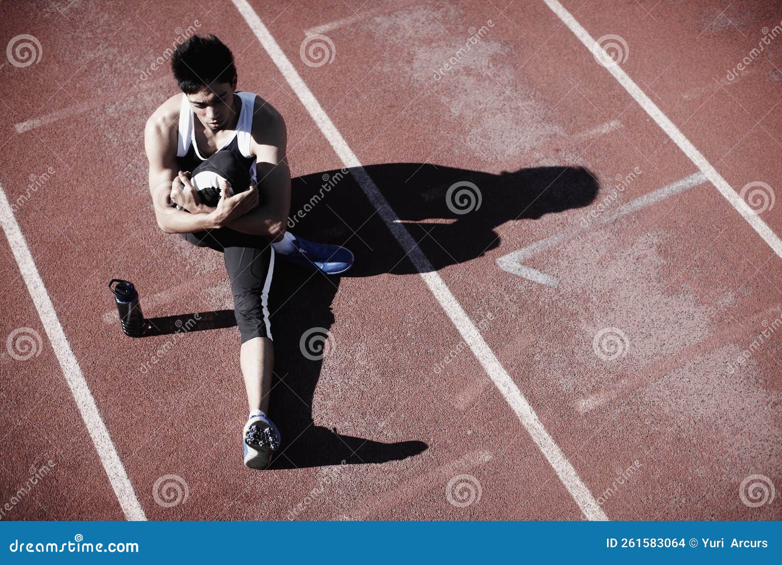 Feeling Defeated. High Angle View of a Young Runner Stretching. Stock ...