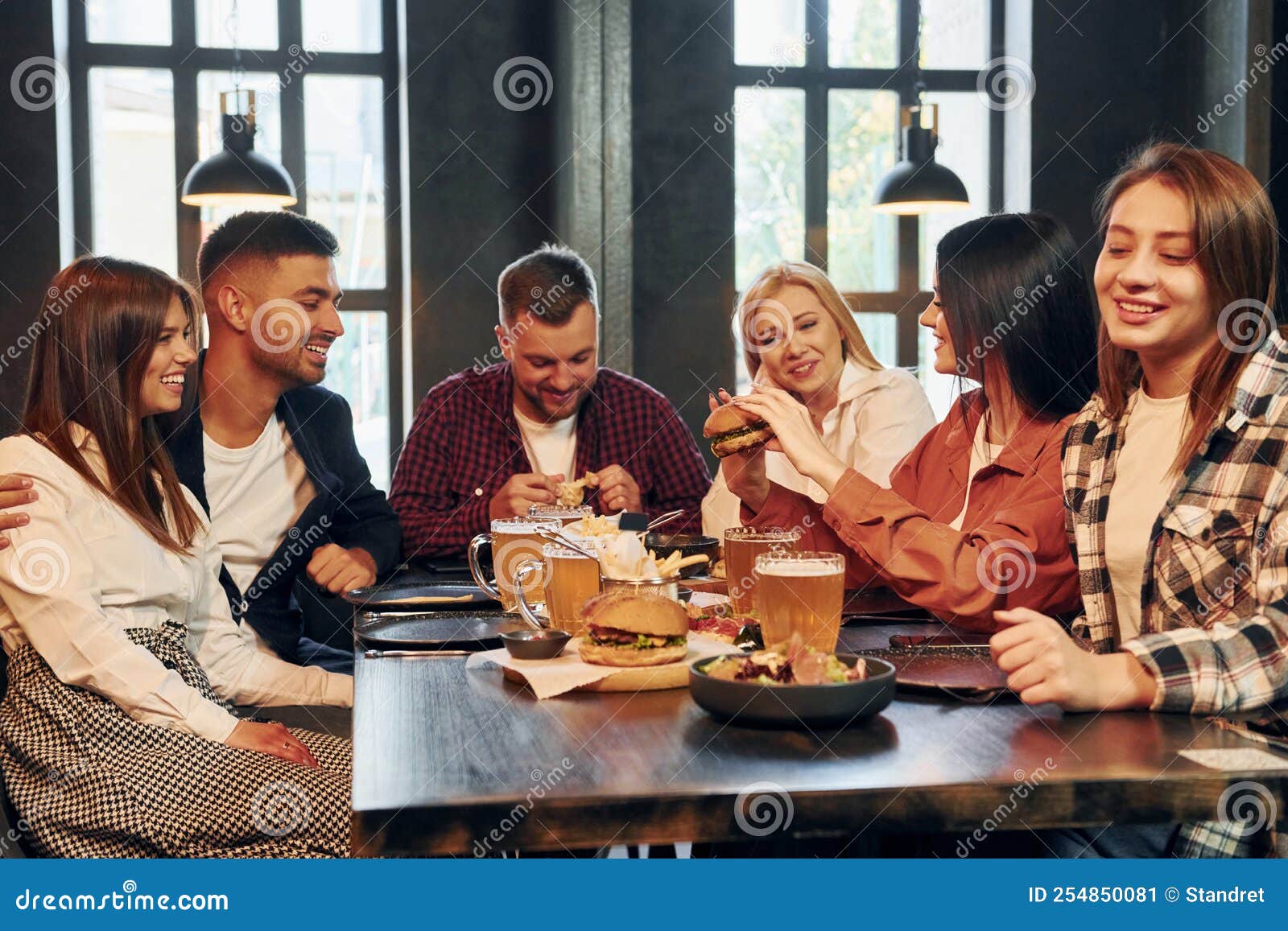 Feeling Joy. Group of Young Friends Sitting Together in Bar with Beer ...