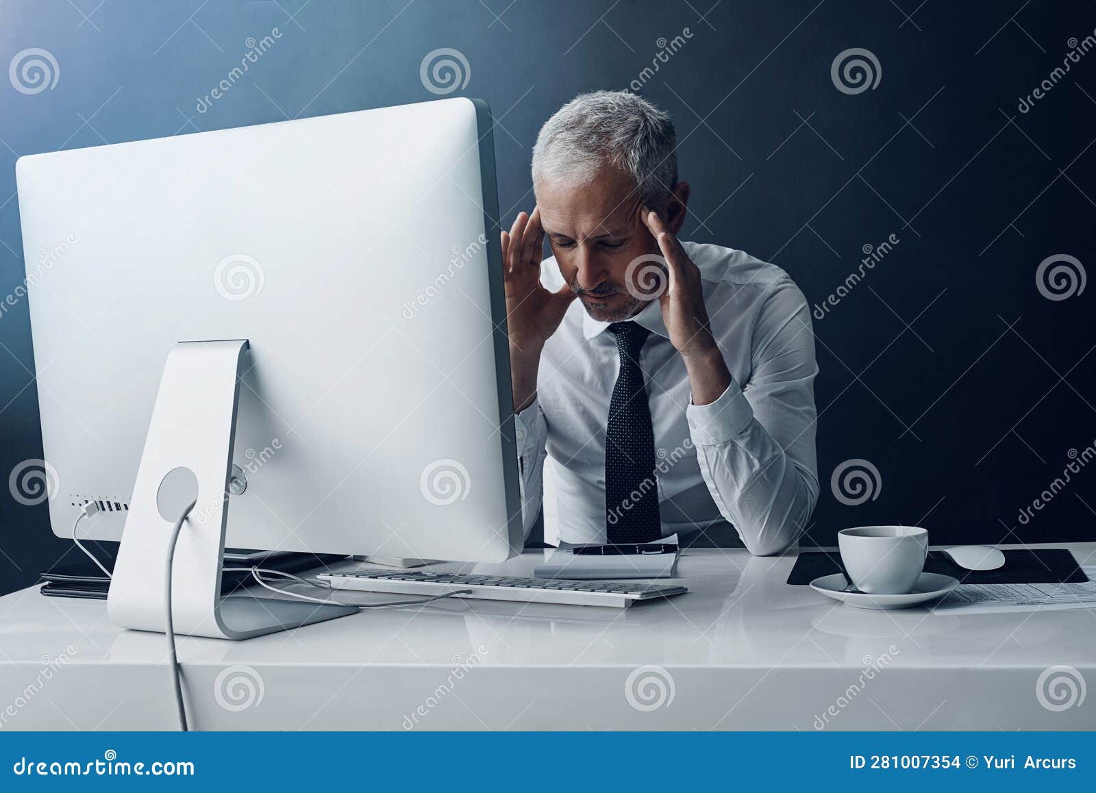 Feeling the Strain. a Mature Businessman Looking Stressed Working on ...