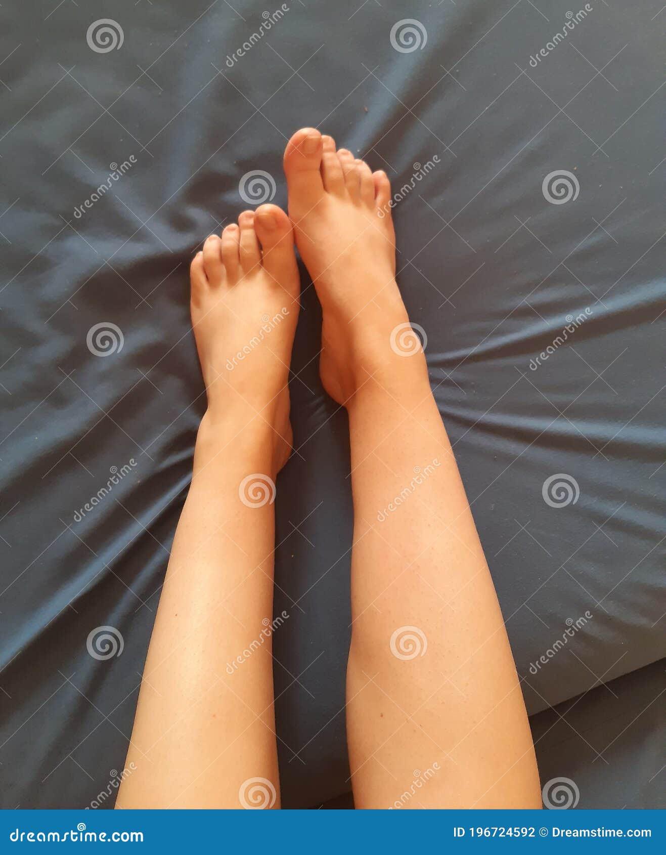 Feet on the bed stock photo. Image of littlefoot, toes - 196724592