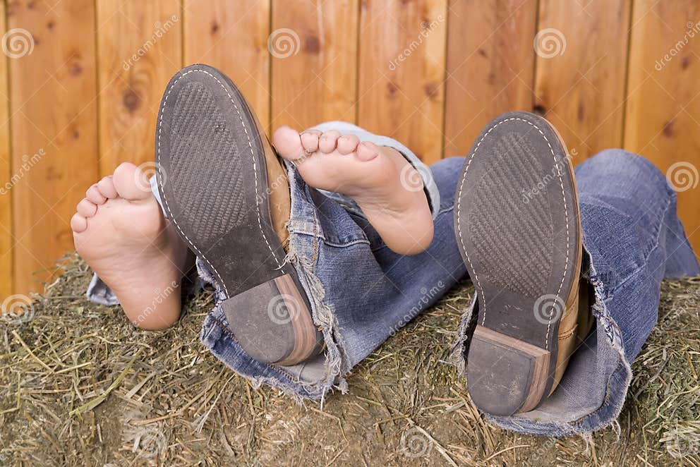 Feet and boots on hay stock photo. Image of affectionate - 12018844