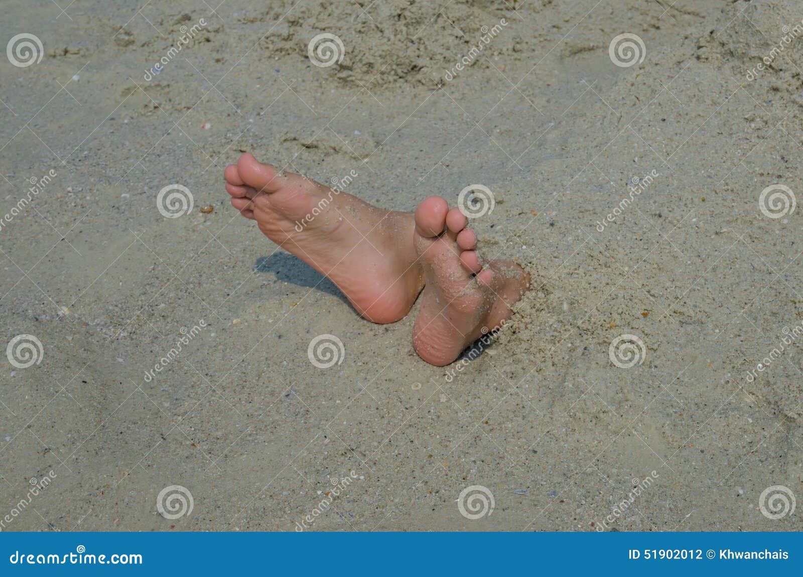 Feet buried in the sand stock photo. Image of summer - 51902012
