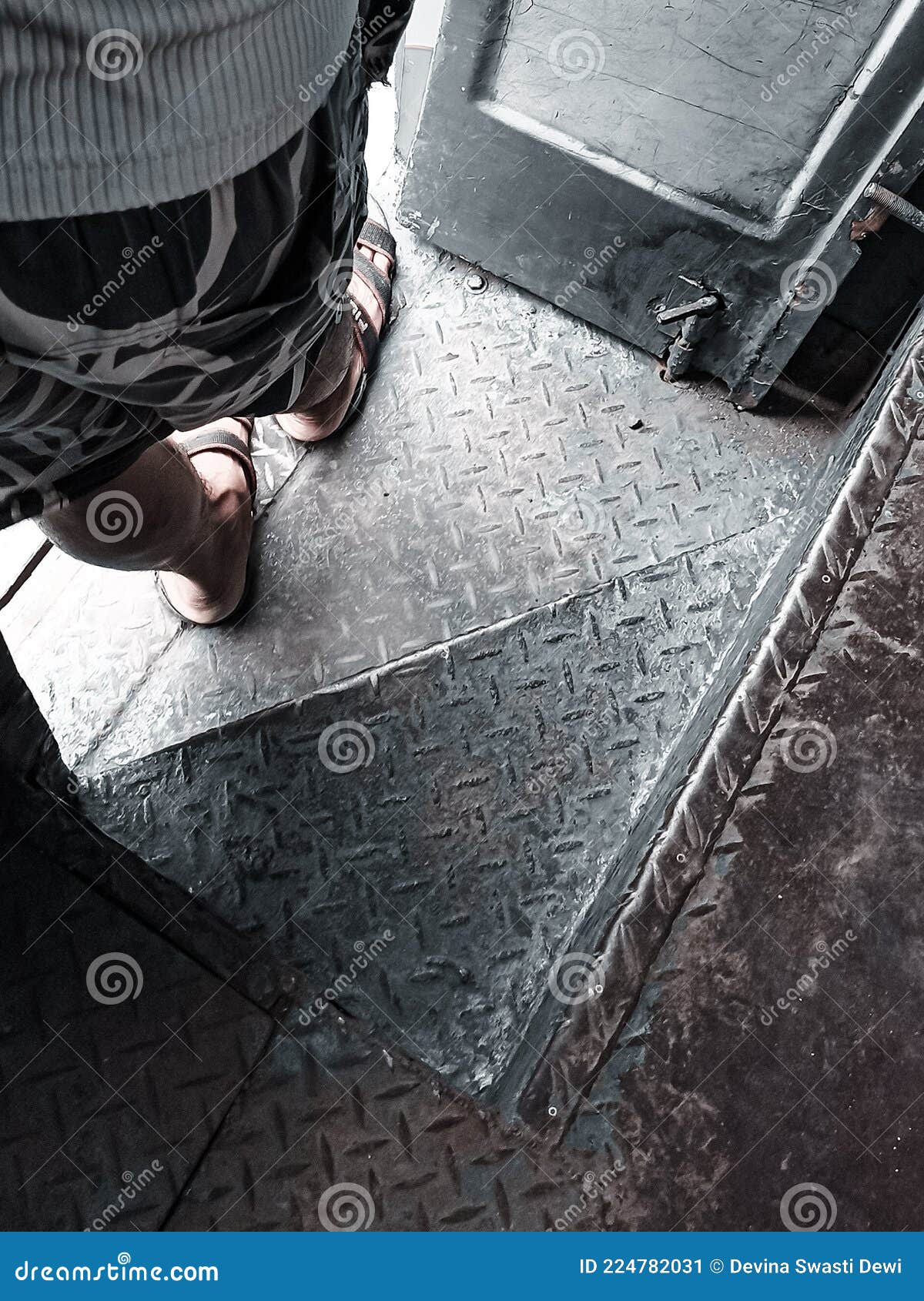 The Feet of a Bus Conductor Standing in Front of the Passenger Door ...