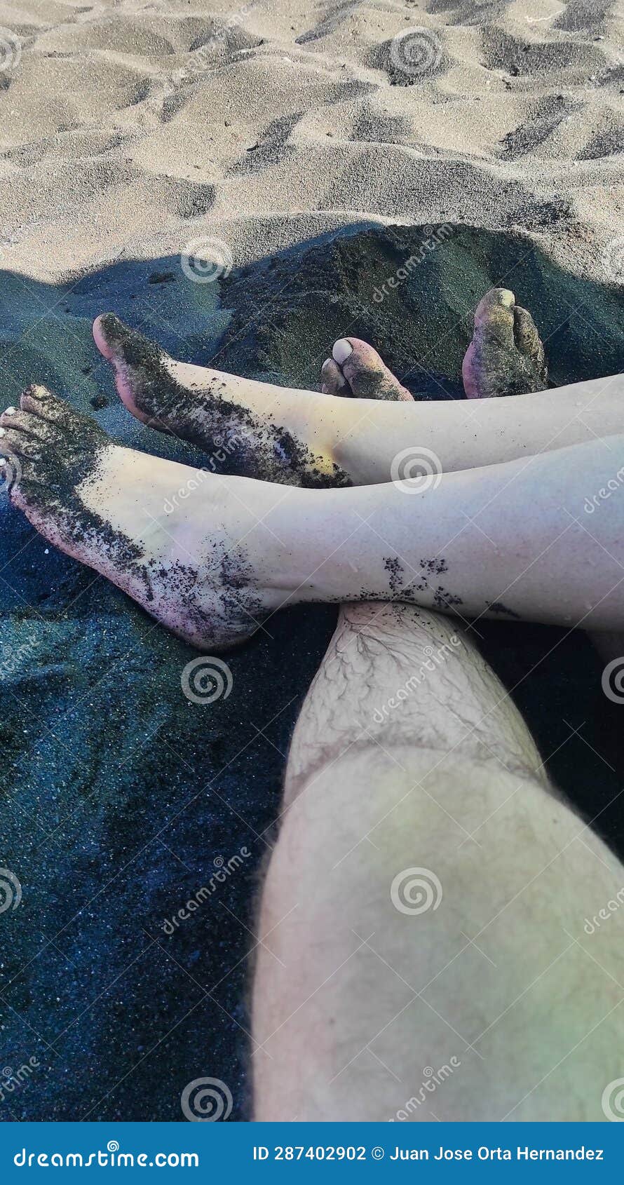 Feet Intertwined in the Sand on the Beach Stock Photo - Image of ...