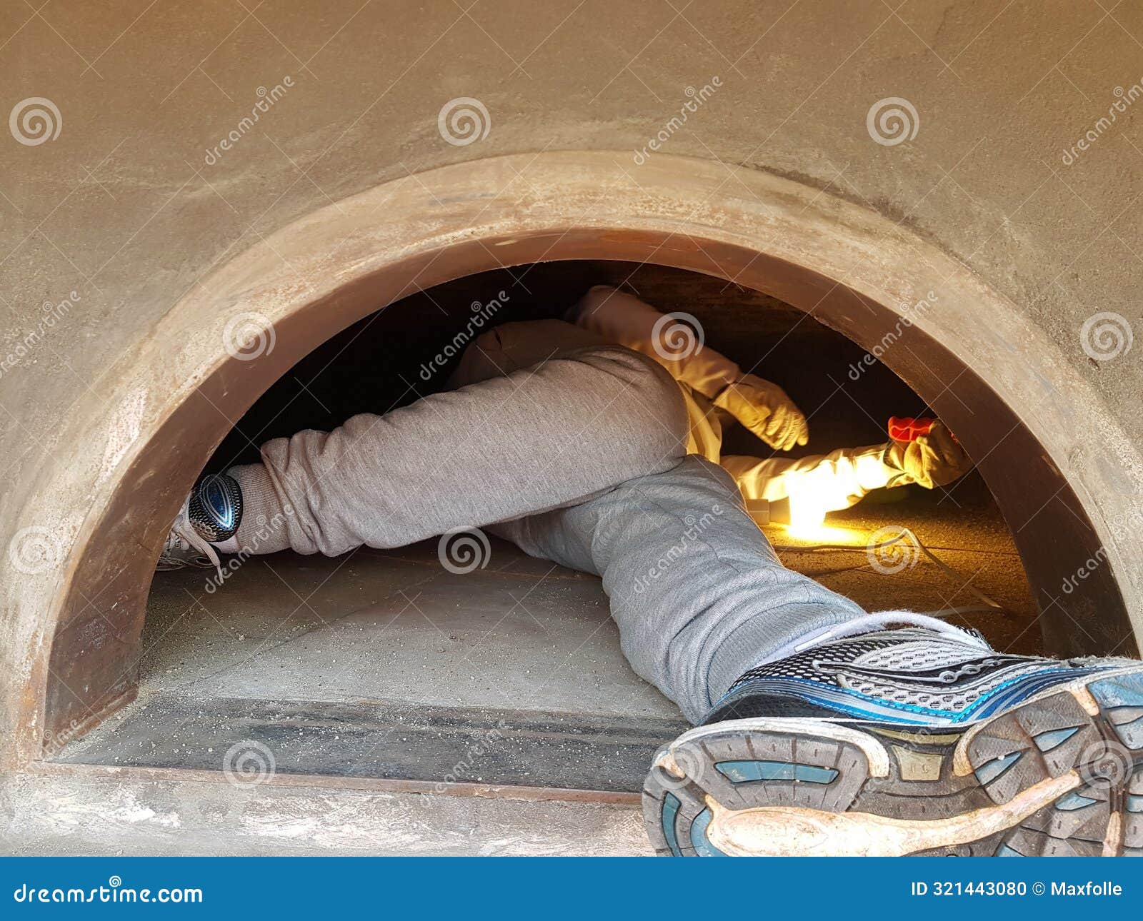 The Feet and Legs of a Person Cleaning the Pizza Oven during ...