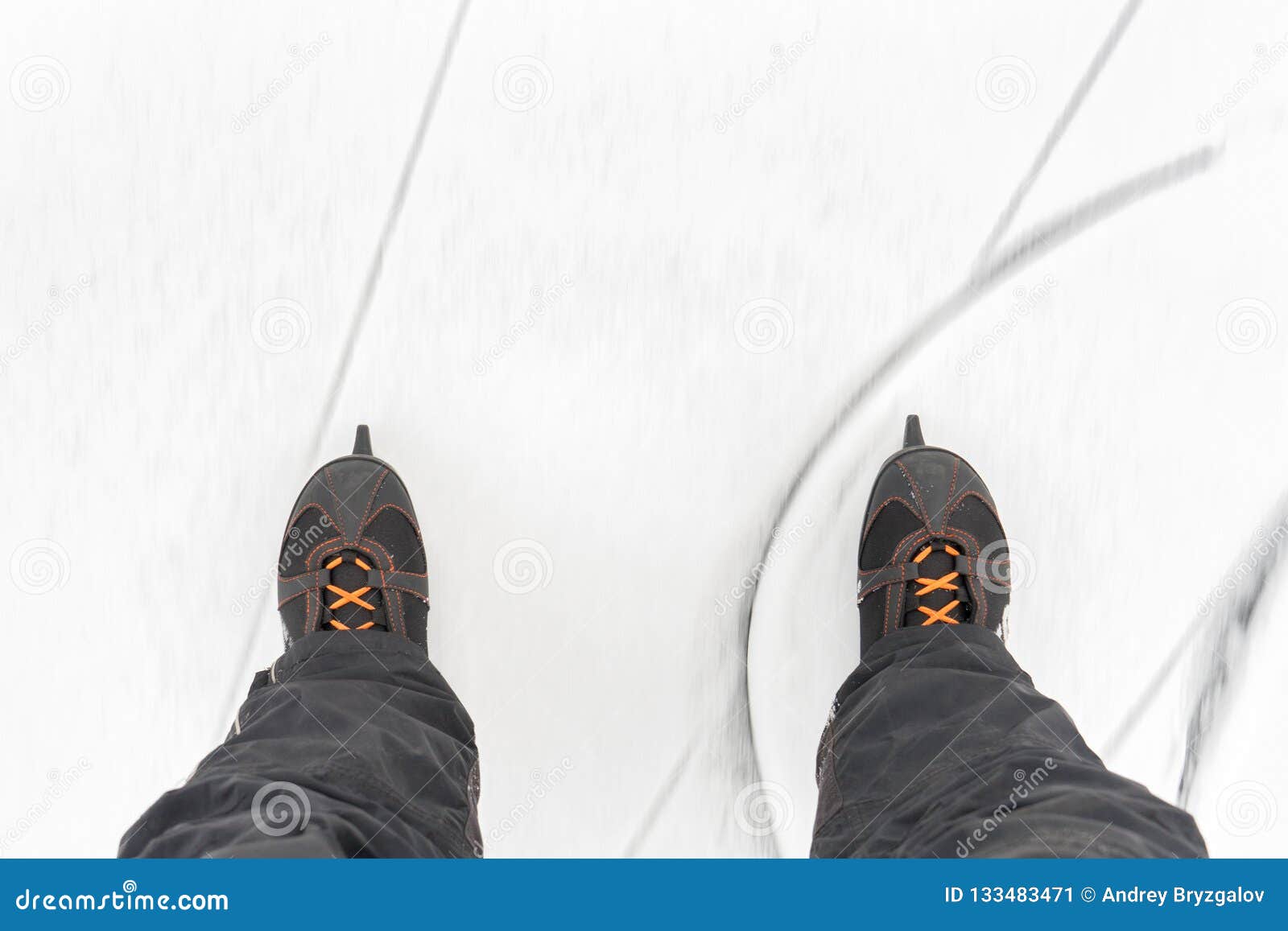 Feet of Man Rolling on Ice Skates on Ice of Frozen River Stock Image ...