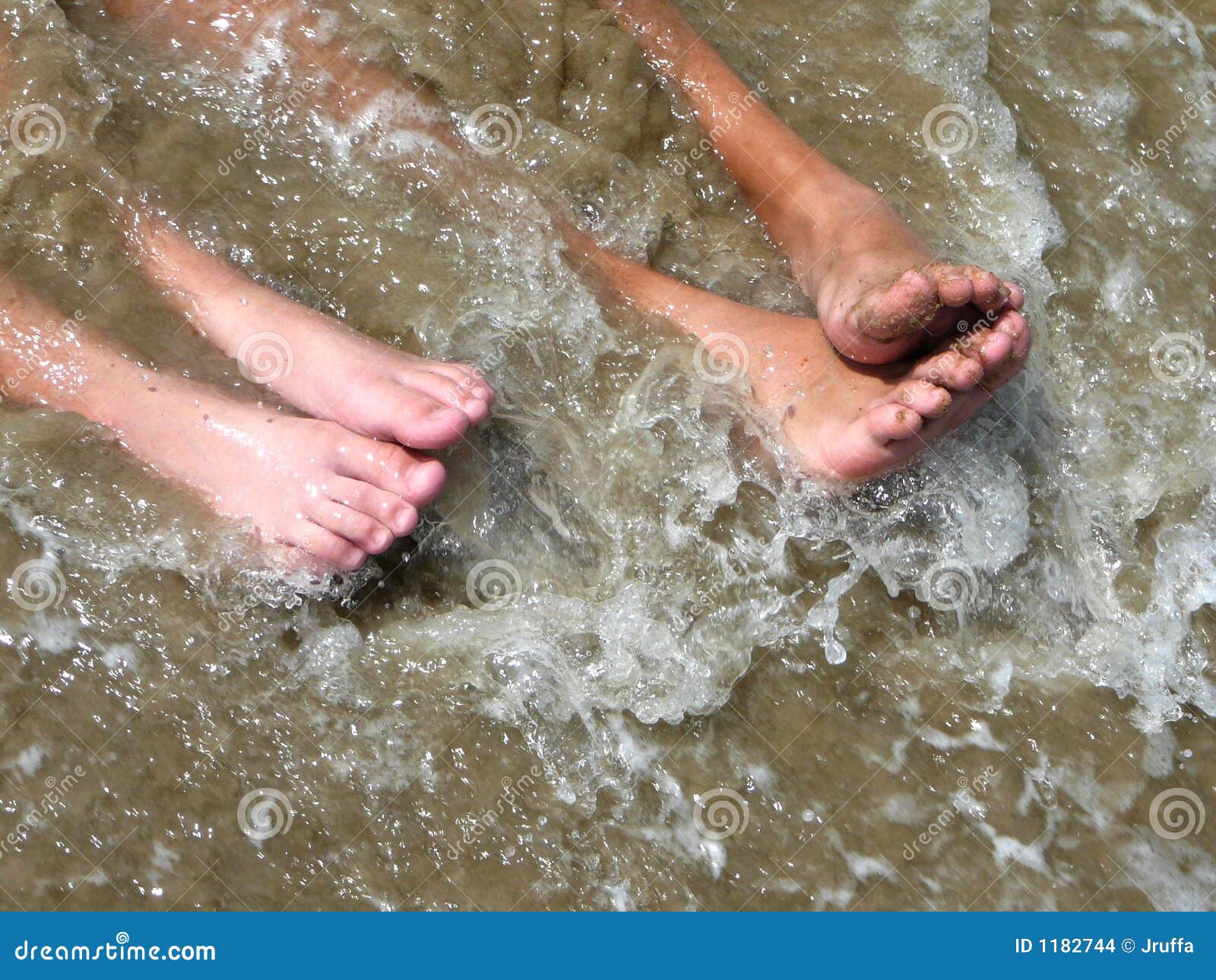 Feet in the ocean surf stock photo. Image of foamy, north - 1182744
