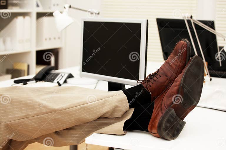 Feet on the office desk stock image. Image of comfortable - 13734527