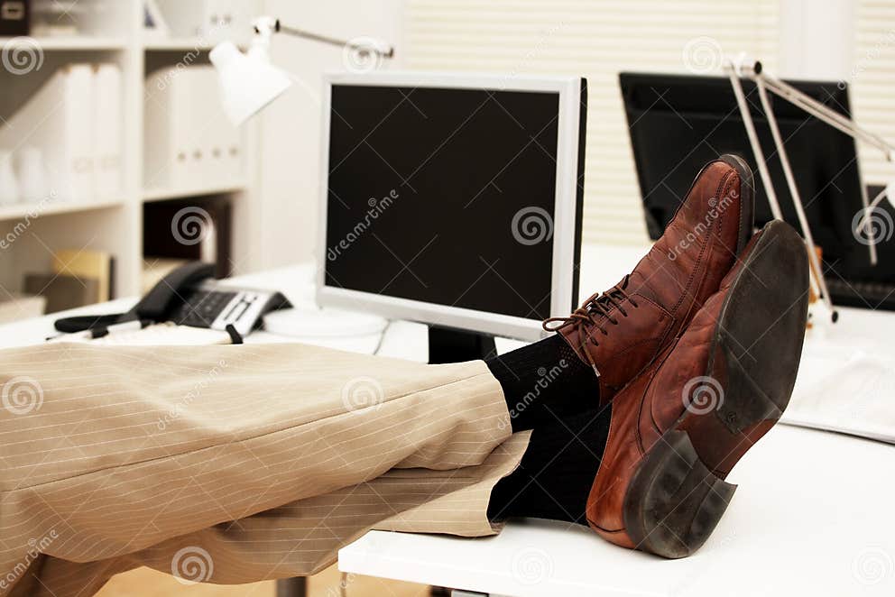 Feet on the office desk stock image. Image of comfortable - 13734527