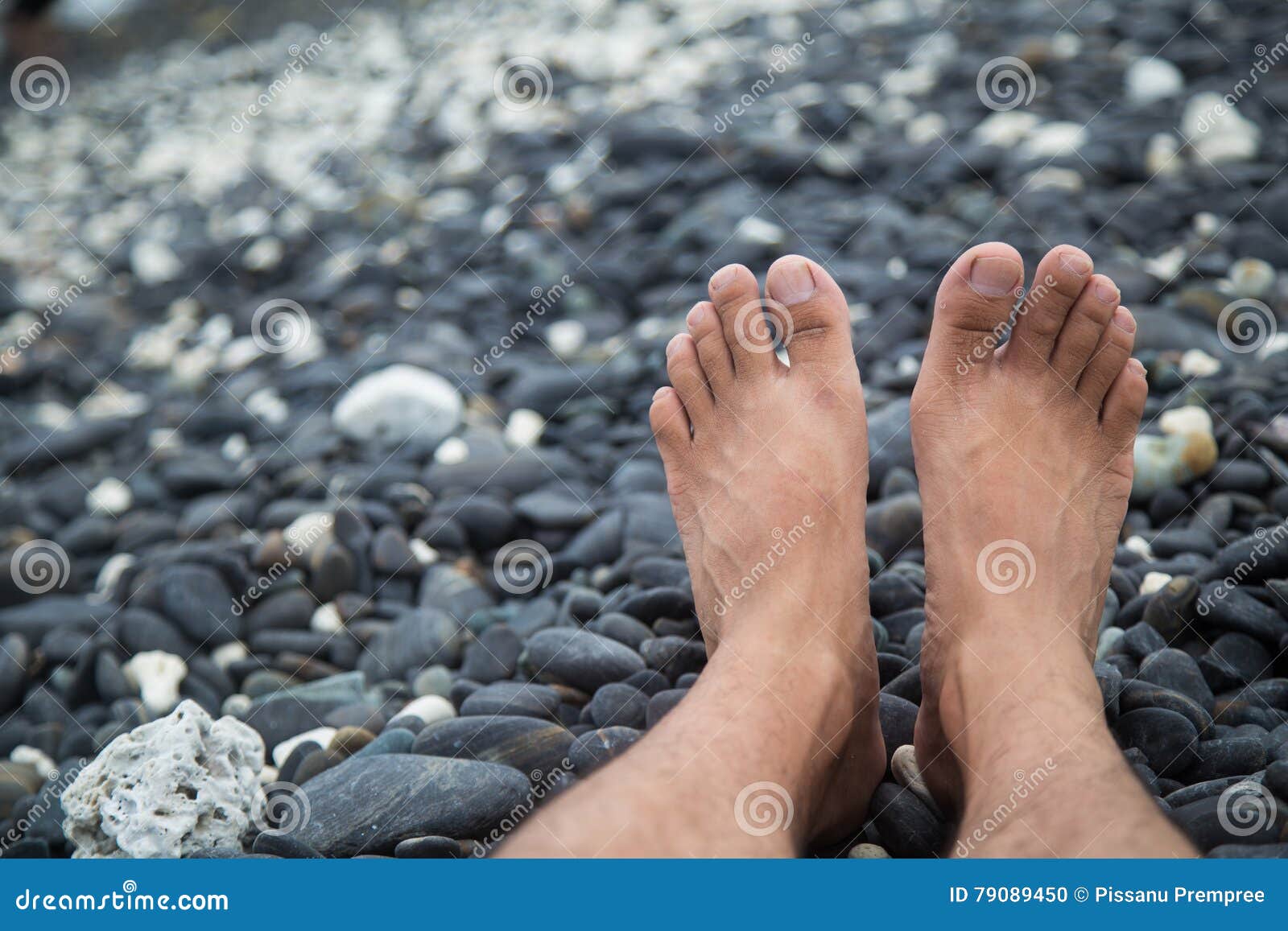 Feet on the rock seashore stock photo. Image of rock - 79089450
