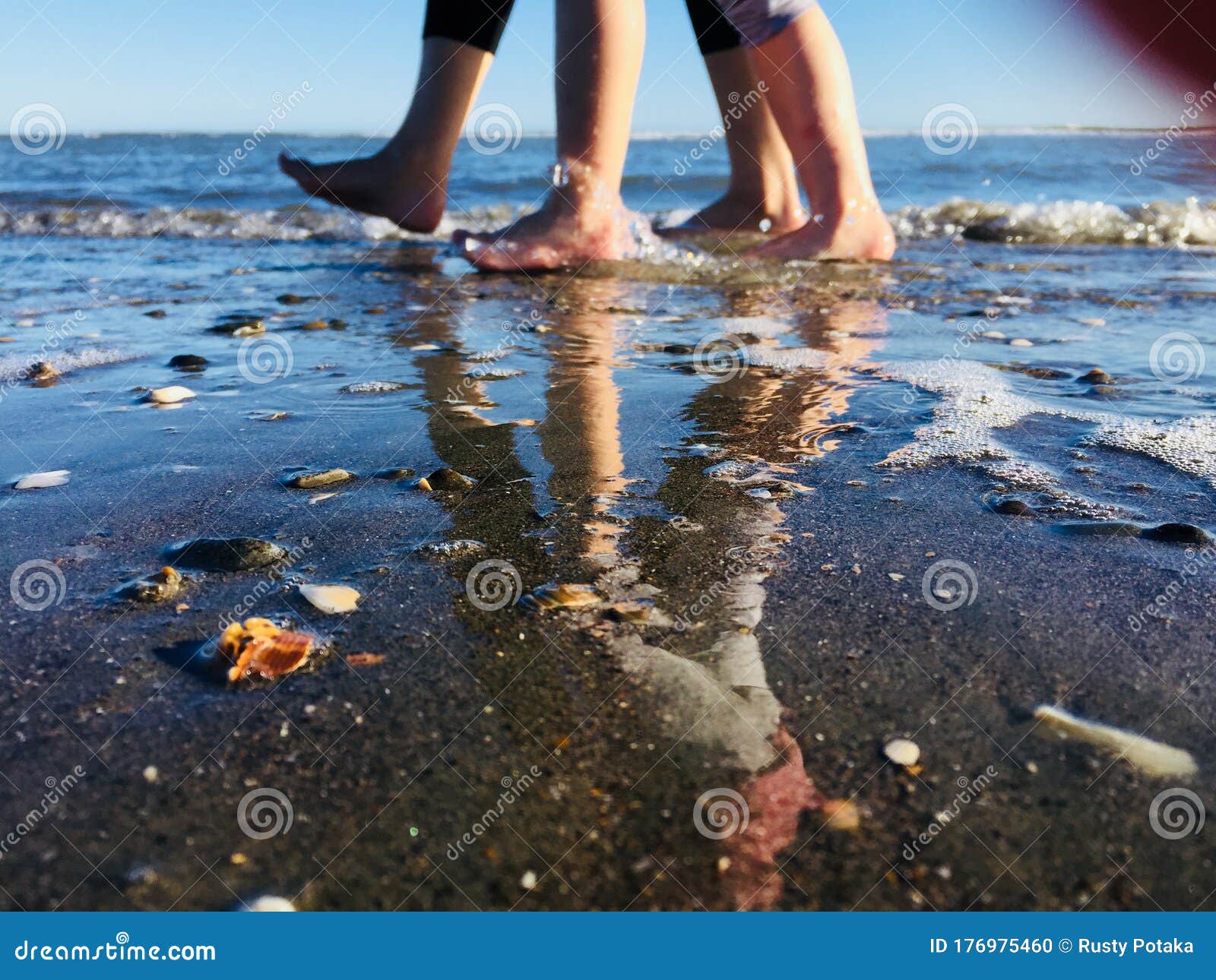 Feet in the Rocky Sand while Waves Crash in Stock Photo - Image of ...