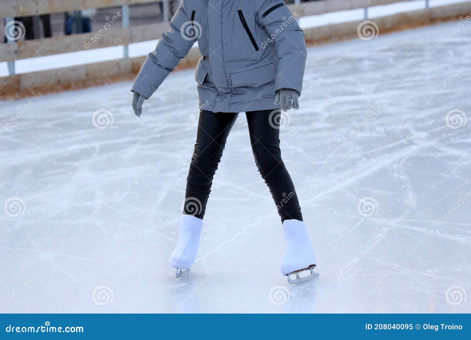 Feet on the Skates of a Person Rolling on the Ice Rink Stock Image ...