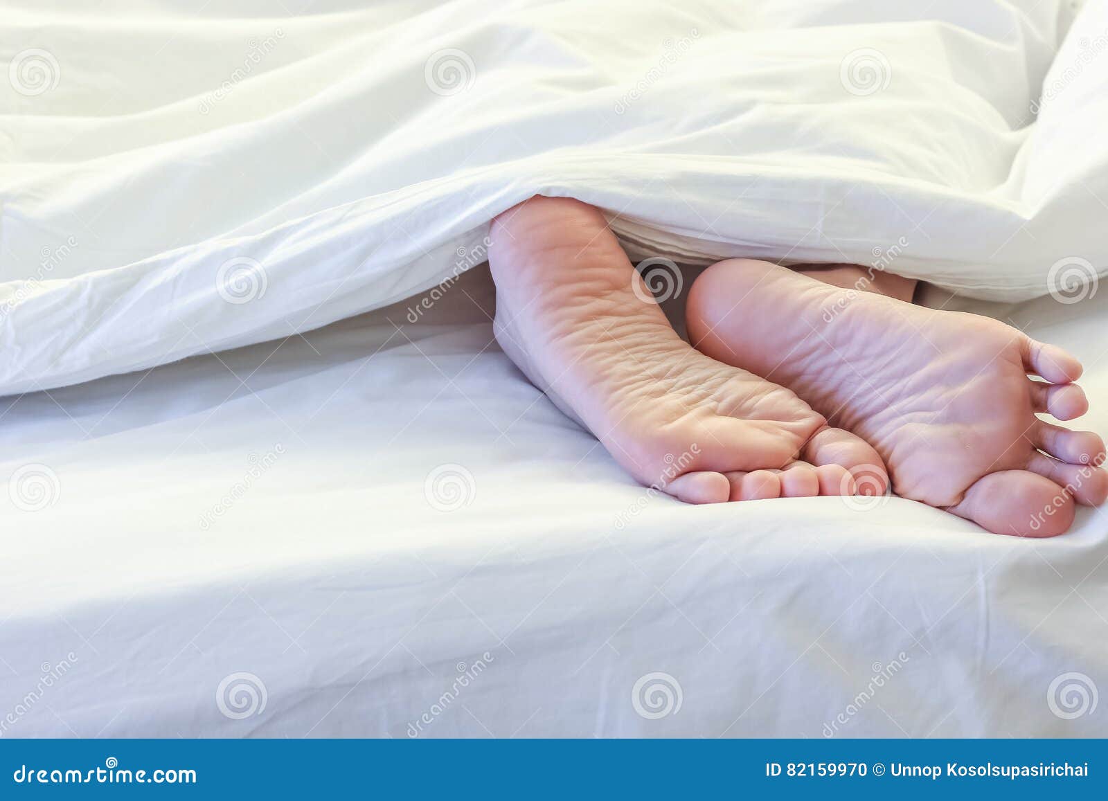 Feet of Sleeping Woman in White Bed Room Stock Photo - Image of comfort ...