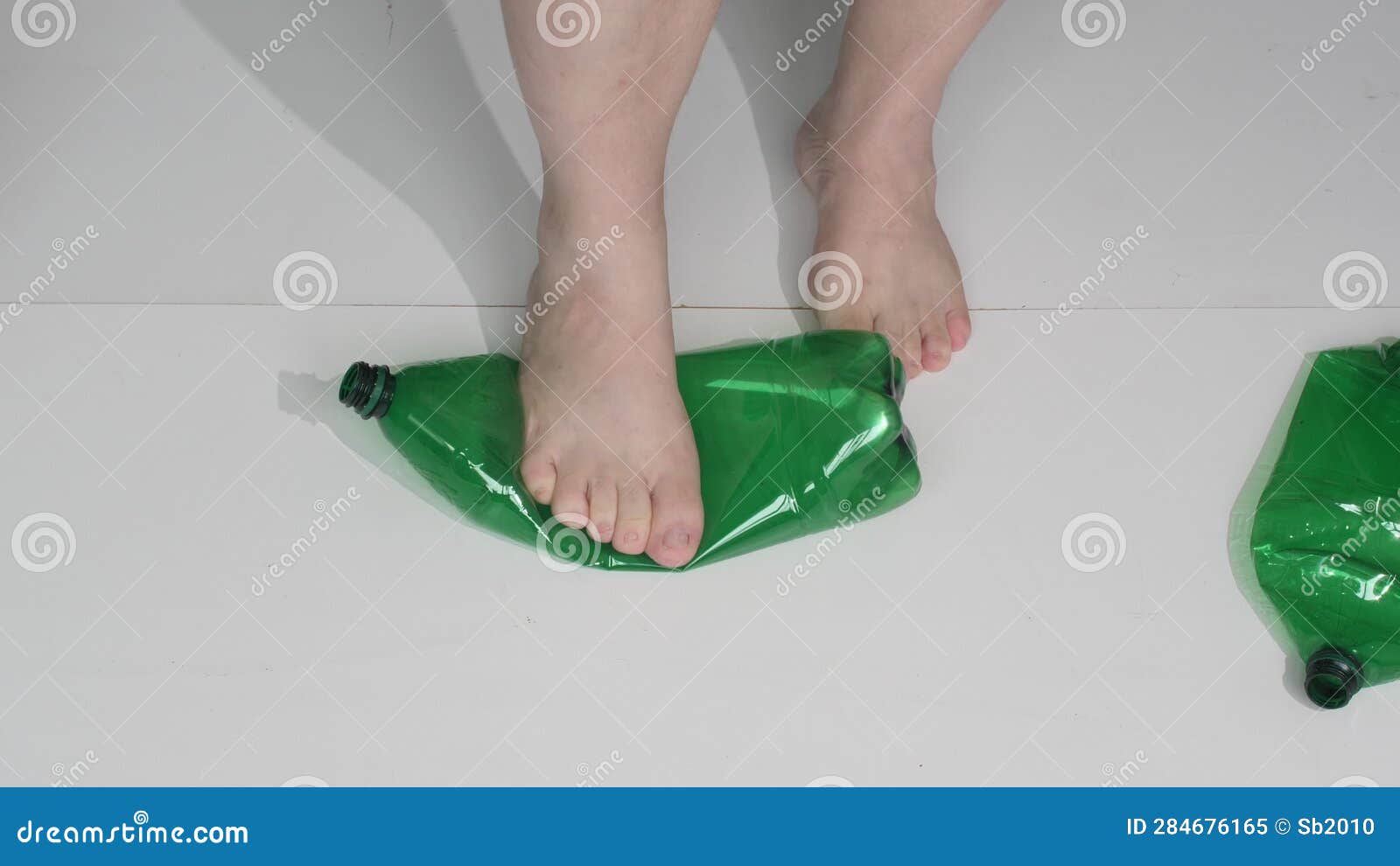 Feet Trample on Plastic Bottles for Disposal. the Concept of Helping ...
