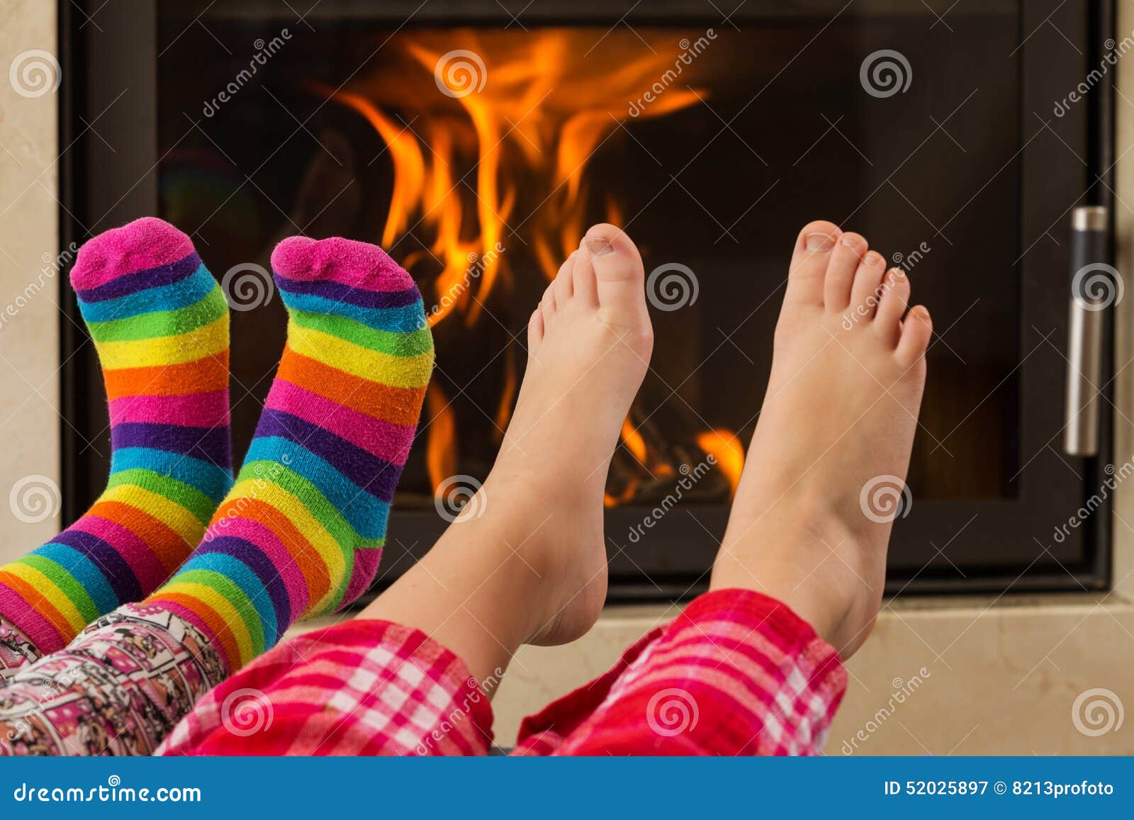Feet warming by fireplace stock image. Image of people - 52025897