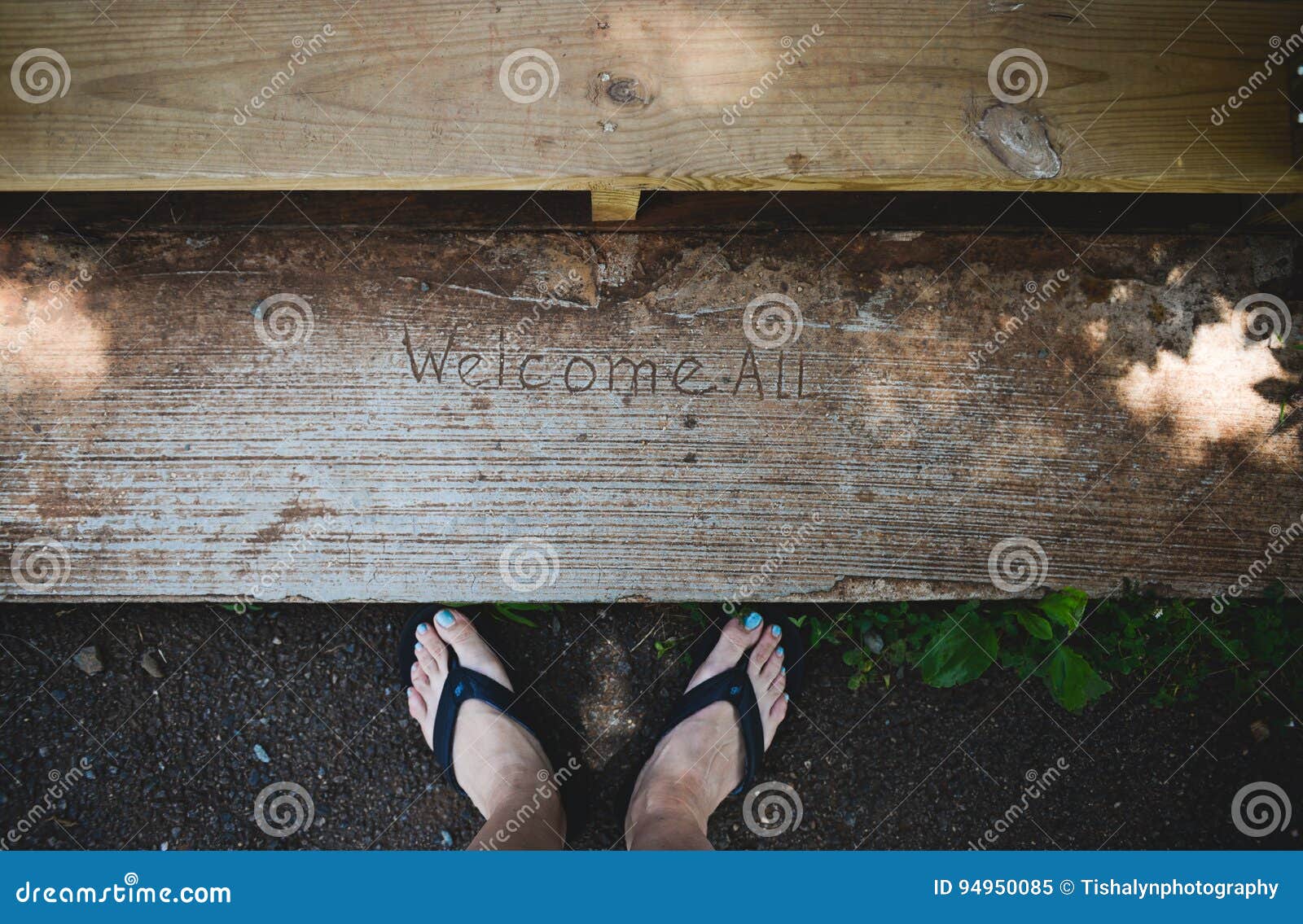 Feet with Welcome All sign stock image. Image of natural - 94950085