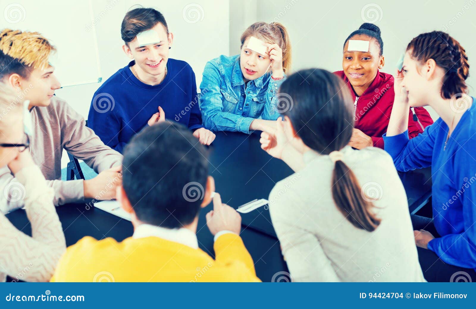 Fellow Students Playing Guess-who Game Stock Photo - Image of dialog ...