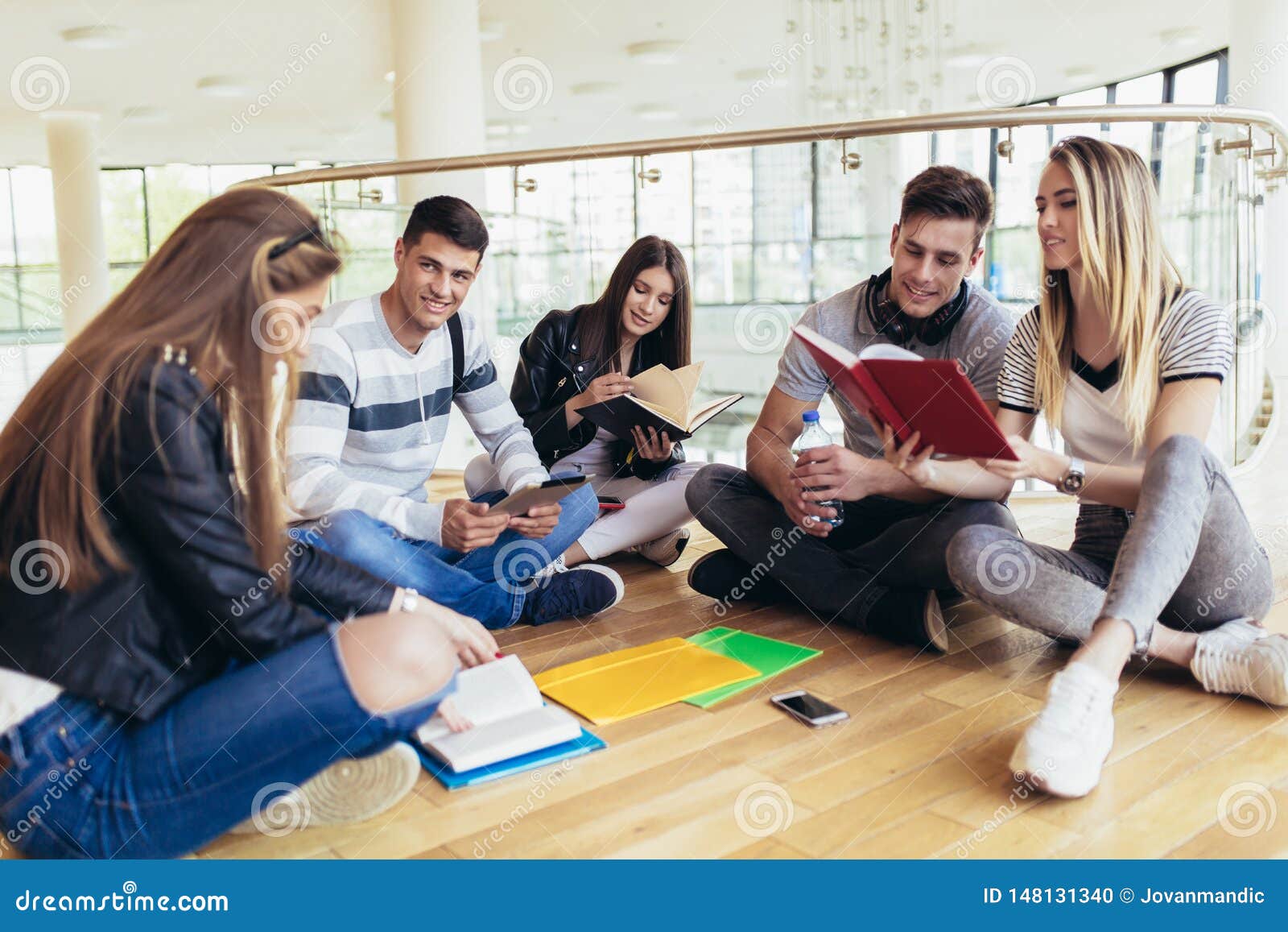 Students Sitting on Floor in Campus and Preparing Together for Exams ...