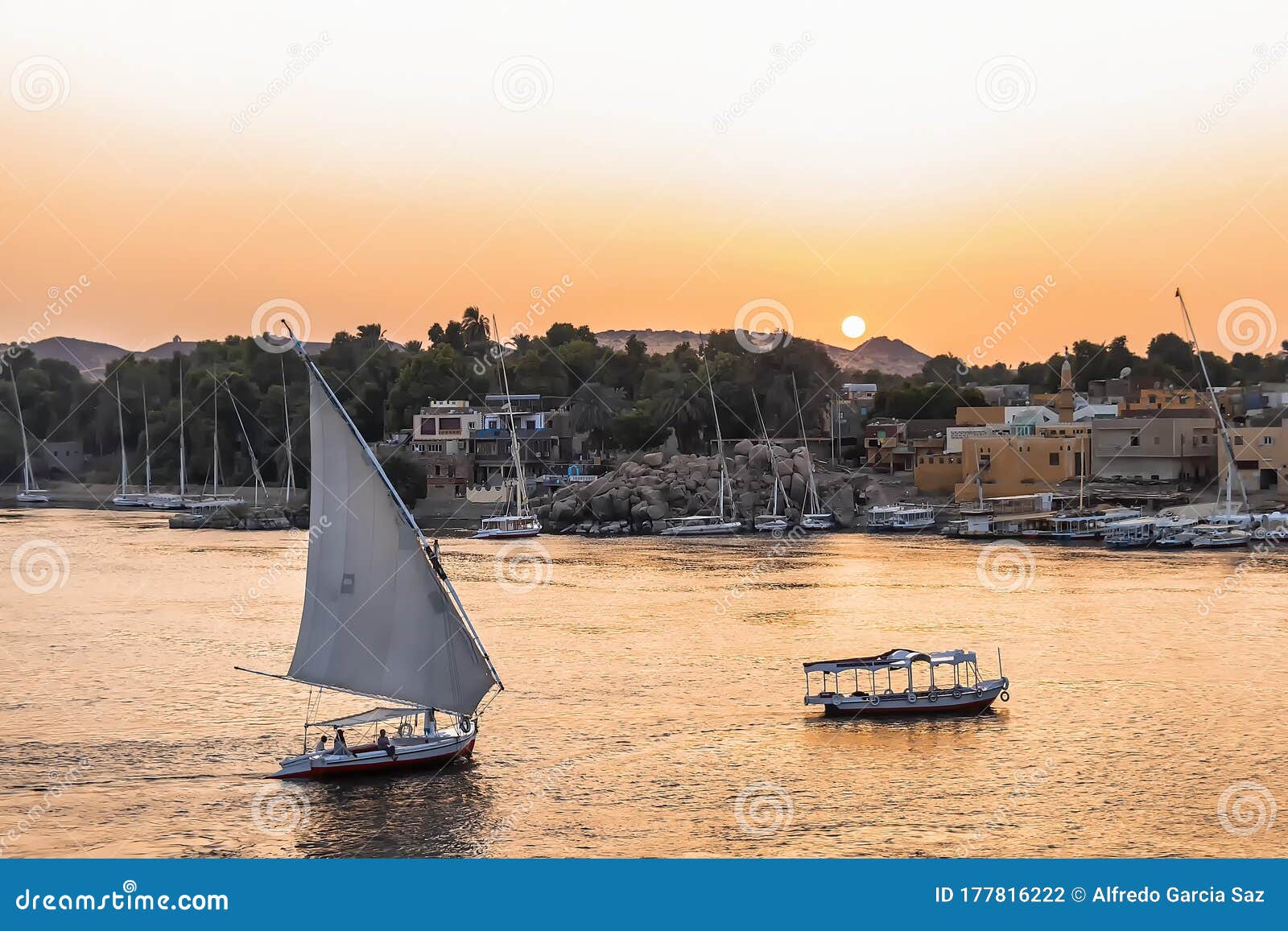 Felucca Boat Sailing on the Nile River at Sunset in Aswan, Egypt Stock ...