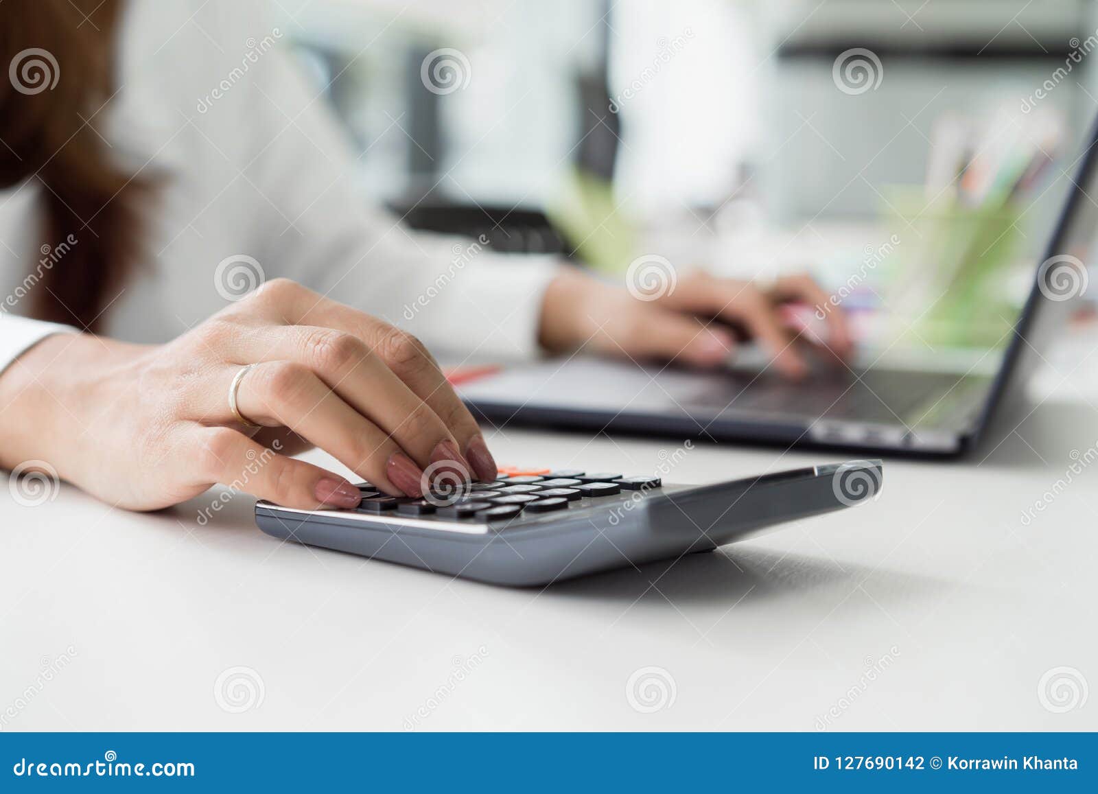 Female Accountant Using Calculator and Typing on Laptop. Stock Photo ... Female Accountant Using Calculator and Typing on Laptop. Stock Photo ...