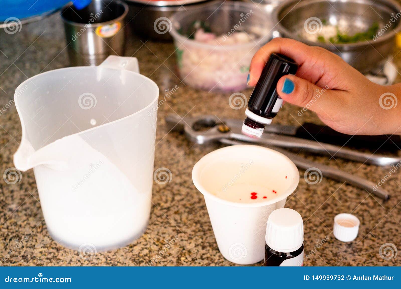 Female Adding Color Drops To Melted Soap Solution on Kitchen Counter ...