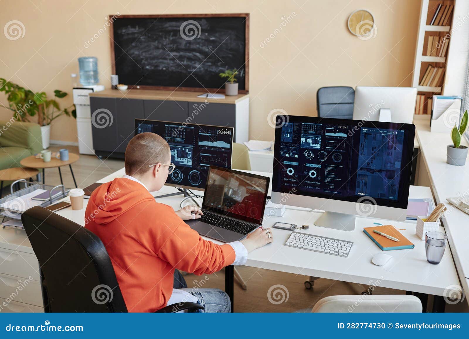 Female Analyst or it Engineer Sitting in Front of Computer Monitor with ...