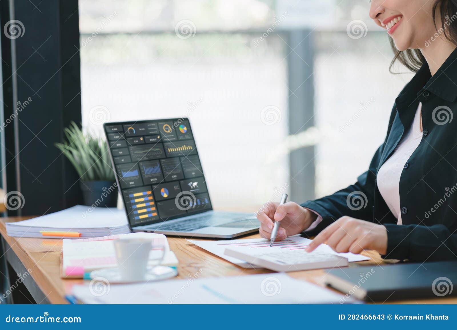 The Female Analyst Utilizes a Computer and a Dashboard for Business ...