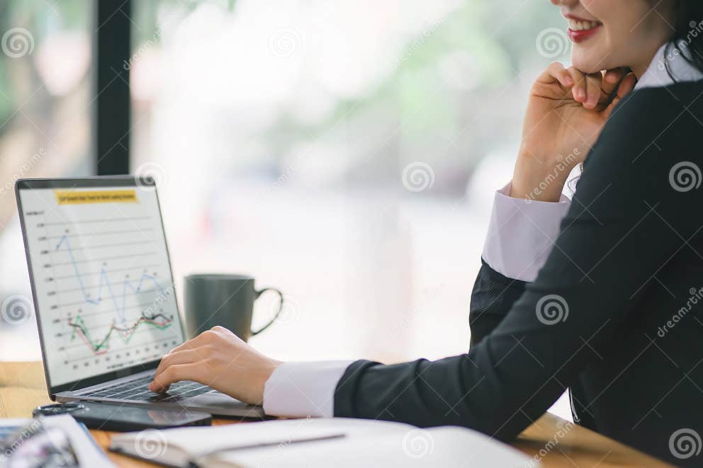 The Female Analyst Utilizes a Computer and a Dashboard for Business ...