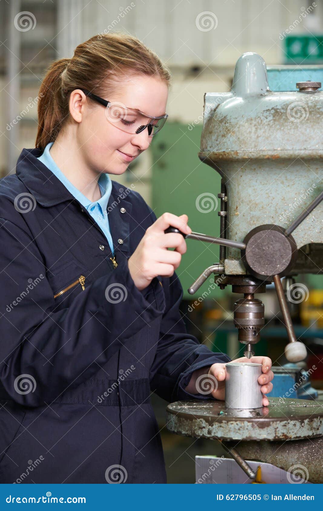 Female Apprentice Engineer Using Drill in Factory Stock Image - Image ...