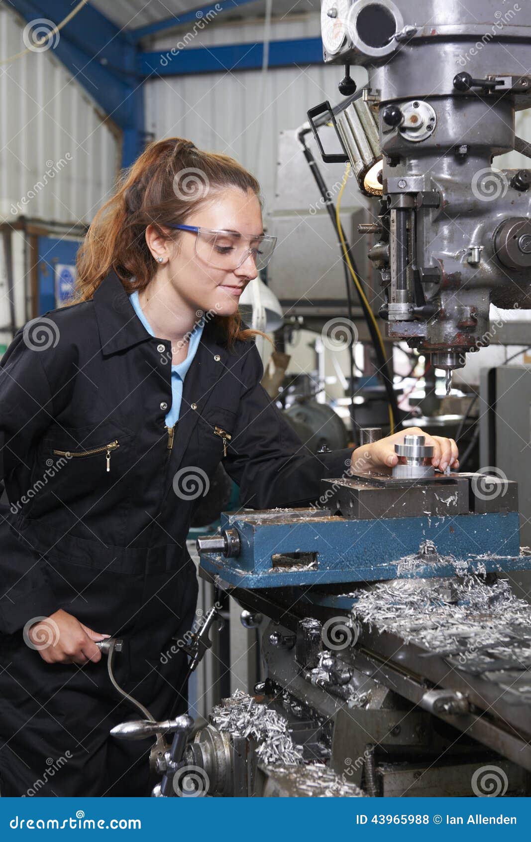 Female Apprentice Engineer Working on Drill in Factory Stock Photo ...
