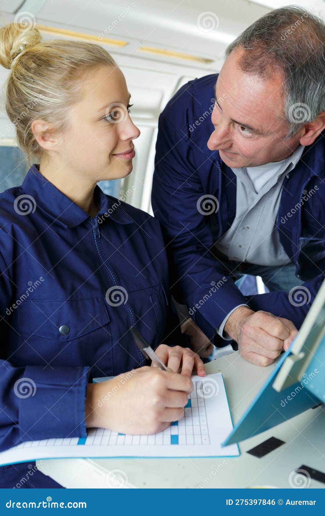 Female Apprentice Focusing on What Teacher Says Stock Photo - Image of ...