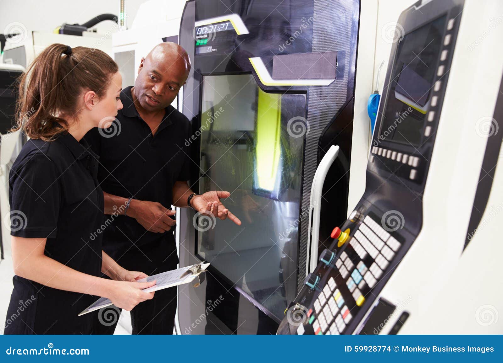 Female Apprentice Working with Engineer on CNC Machinery Stock Photo ...