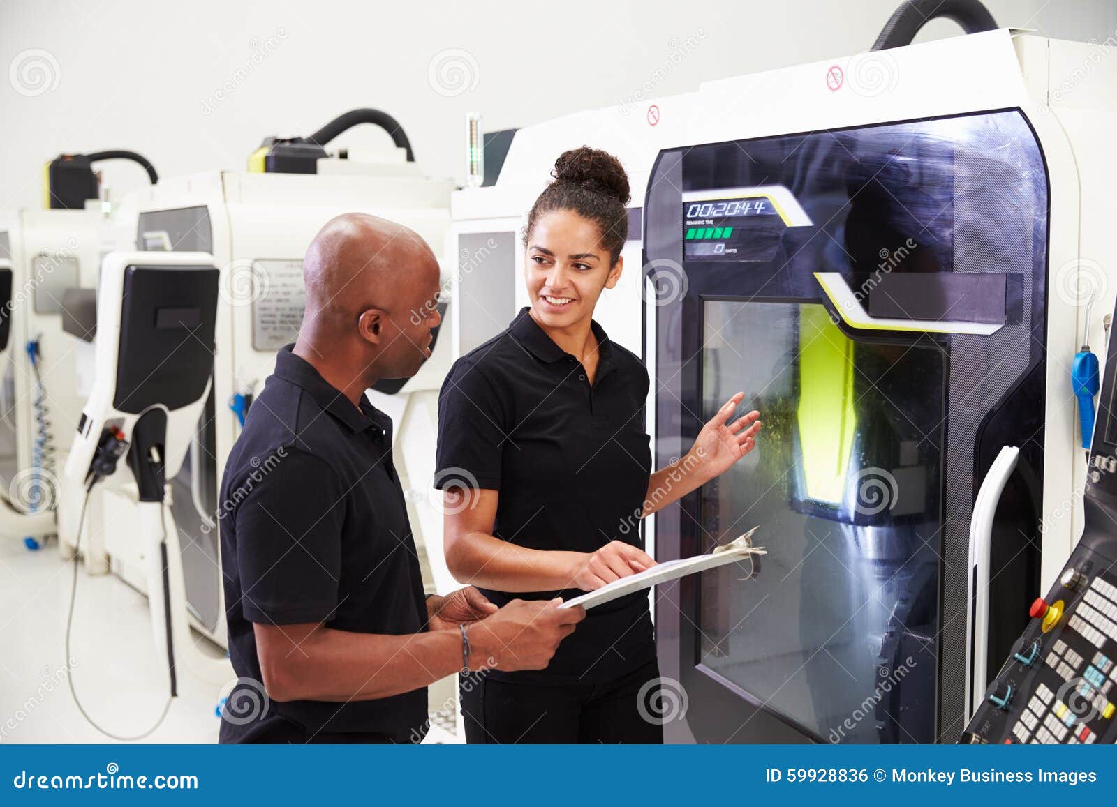 Female Apprentice Working with Engineer on CNC Machinery Stock Photo ...