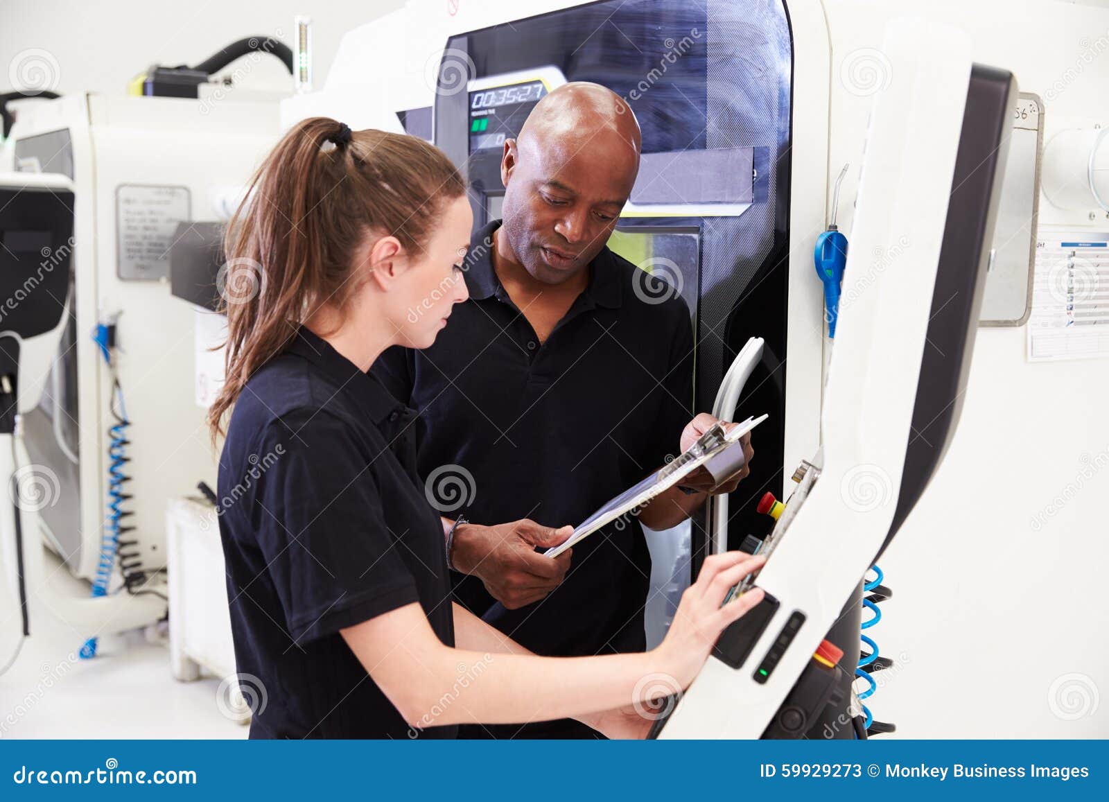 Female Apprentice Working with Engineer on CNC Machinery Stock Image ...
