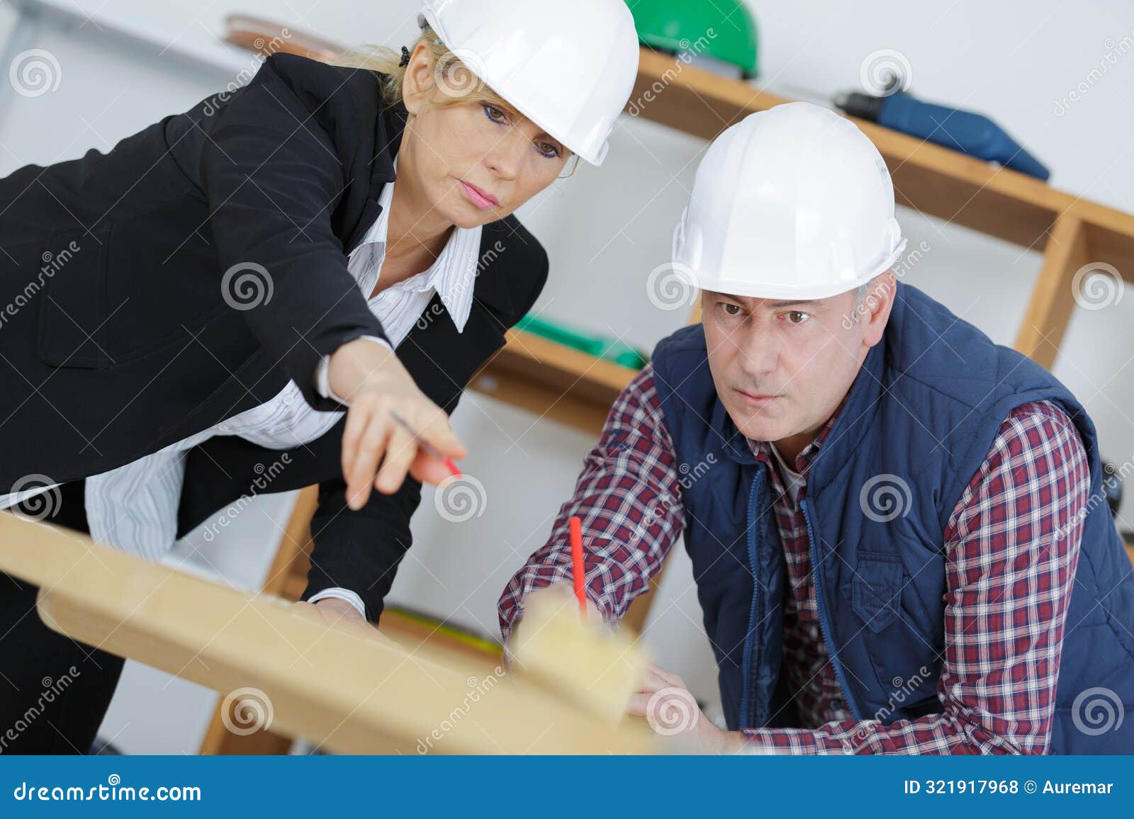 Female Architect and Construction Worker Looking at Scale Model Stock ...
