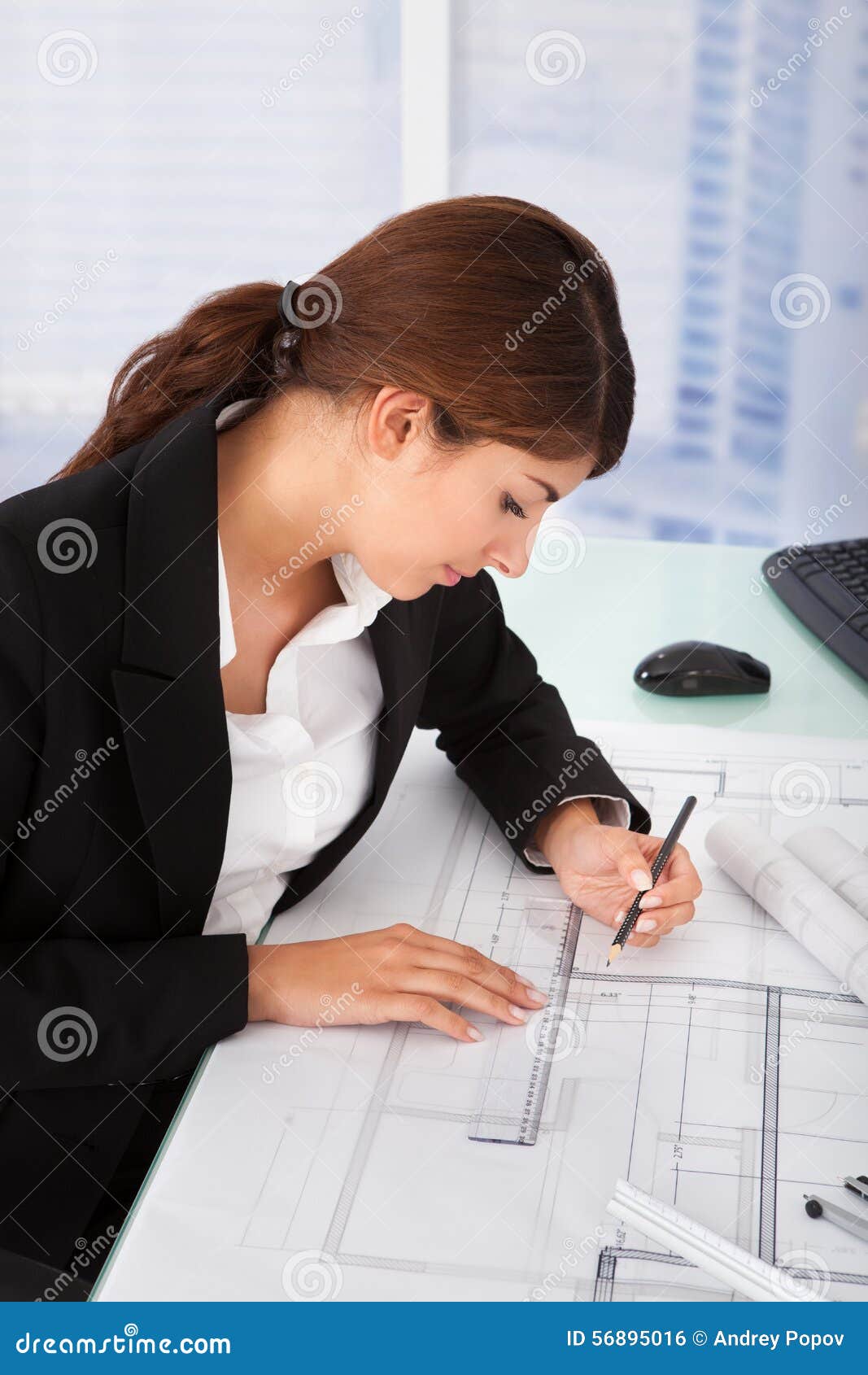 Female Architect Working on Blueprint at Desk Stock Photo - Image of ...