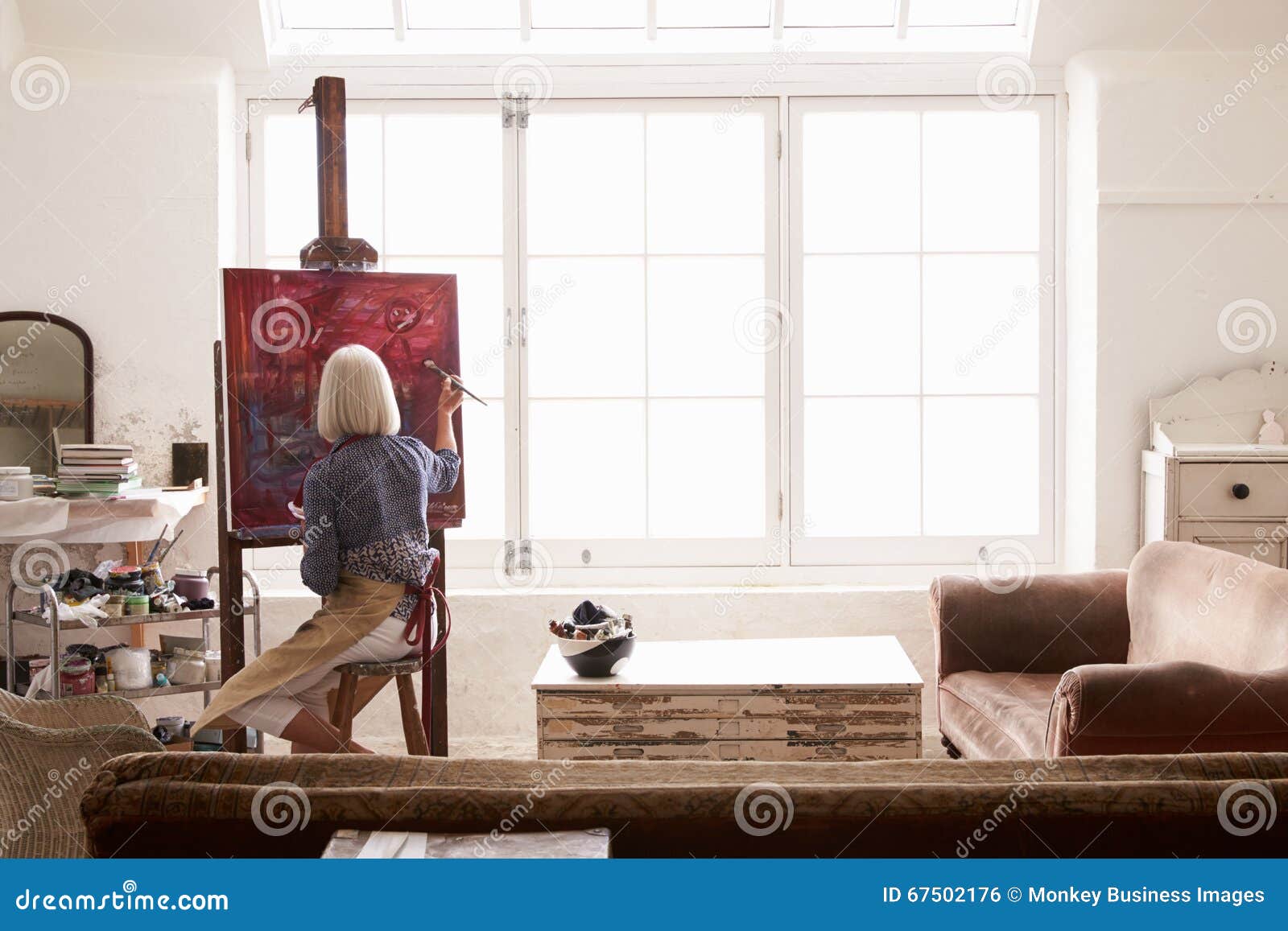 Female Artist Working on Painting in Bright Daylight Studio Stock Photo ...