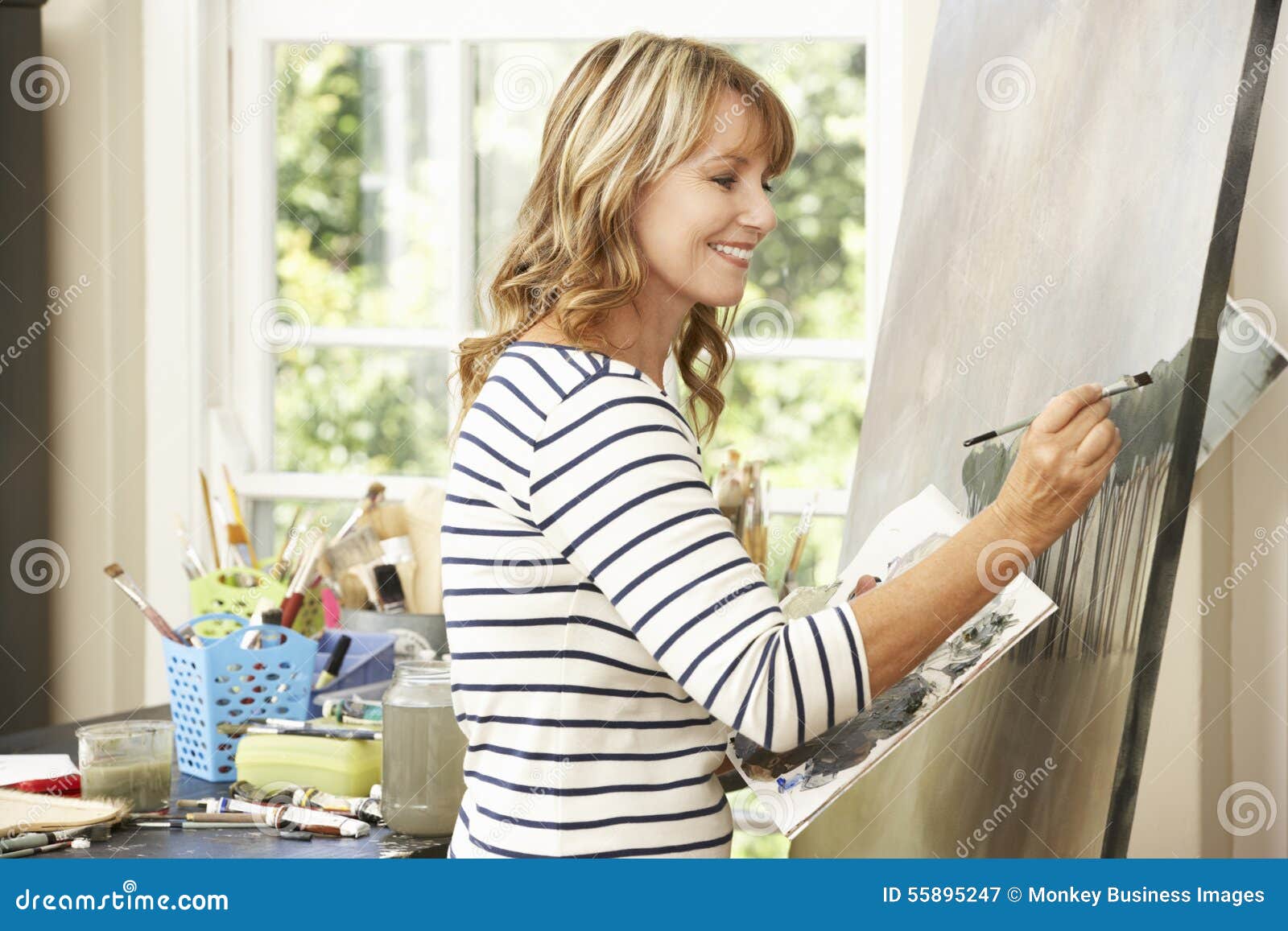 Female Artist Working on Painting in Studio Stock Image - Image of ...