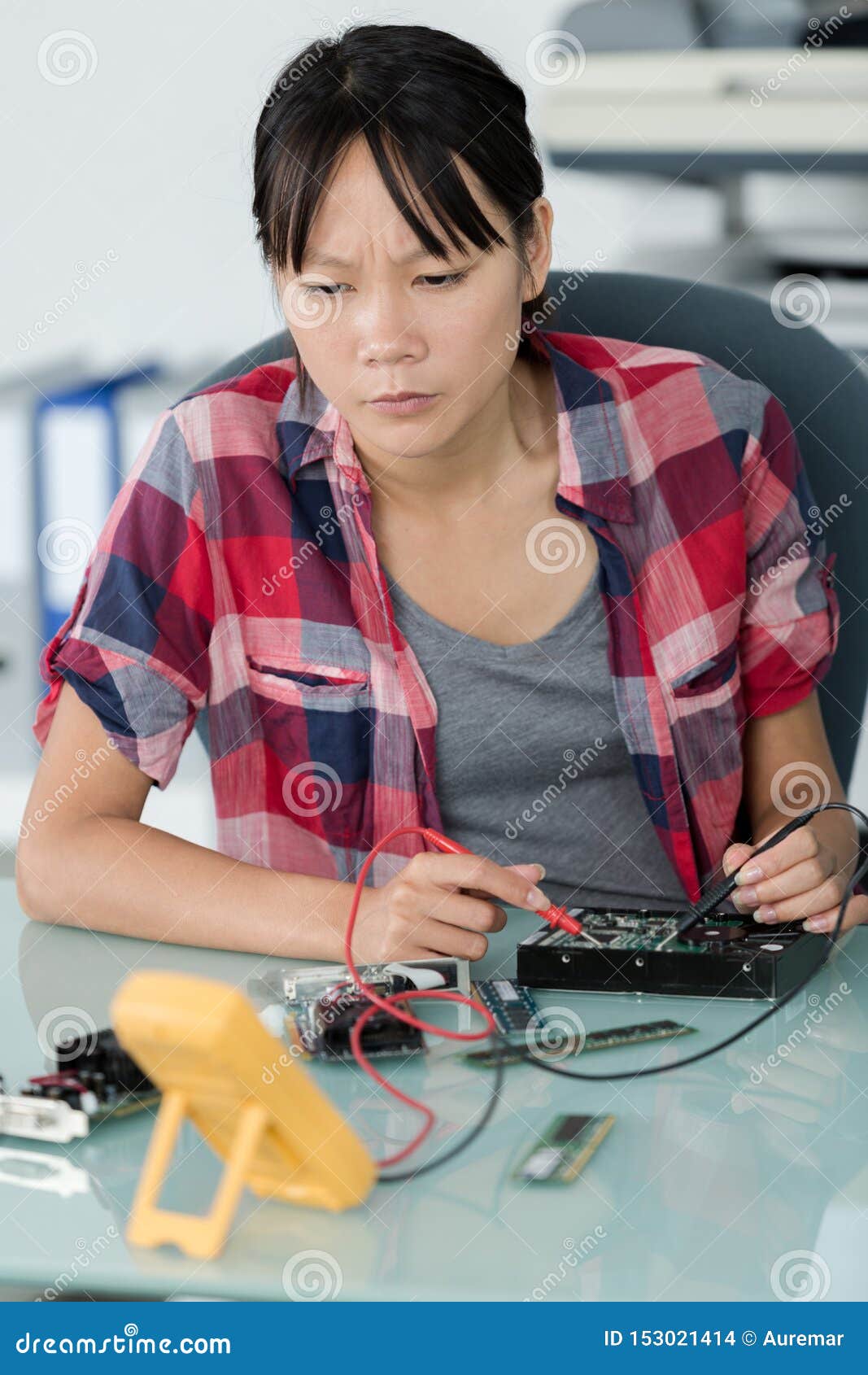 Female Asian Computer Technician Using Multimeter Stock Photo - Image ...