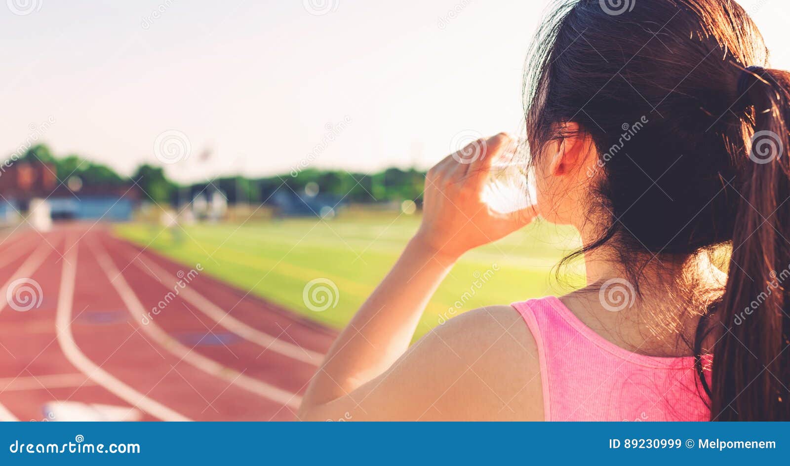 Female Athlete Drinking Water on a Running Track Stock Image - Image of ...