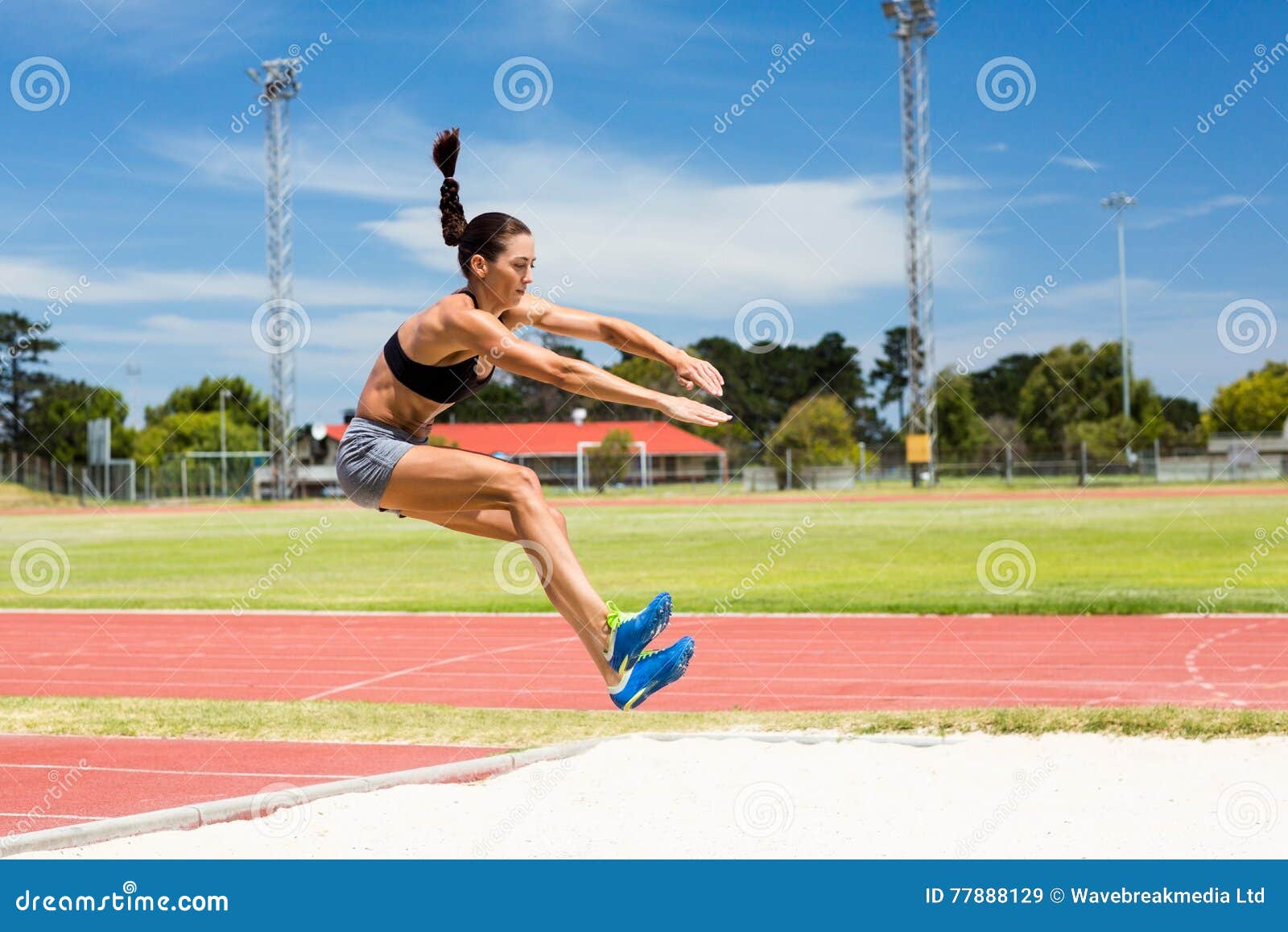 Female Athlete Performing a Long Jump Stock Image - Image of cloud ...