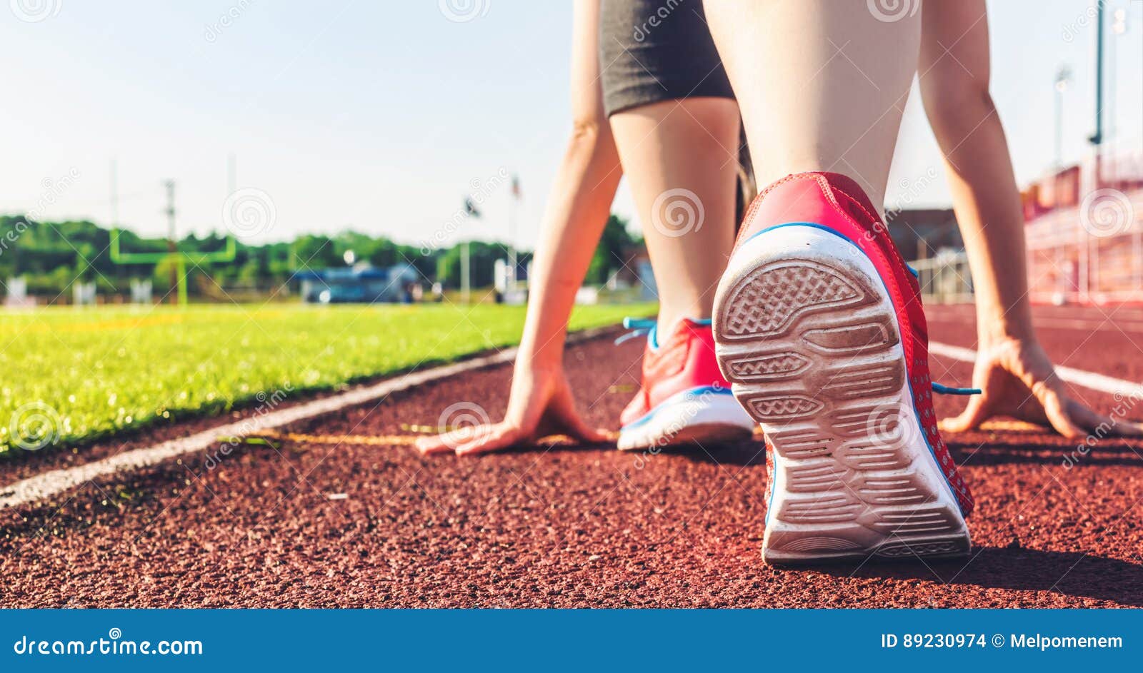 Female Athlete on the Starting Line of a Stadium Track Stock Photo ...