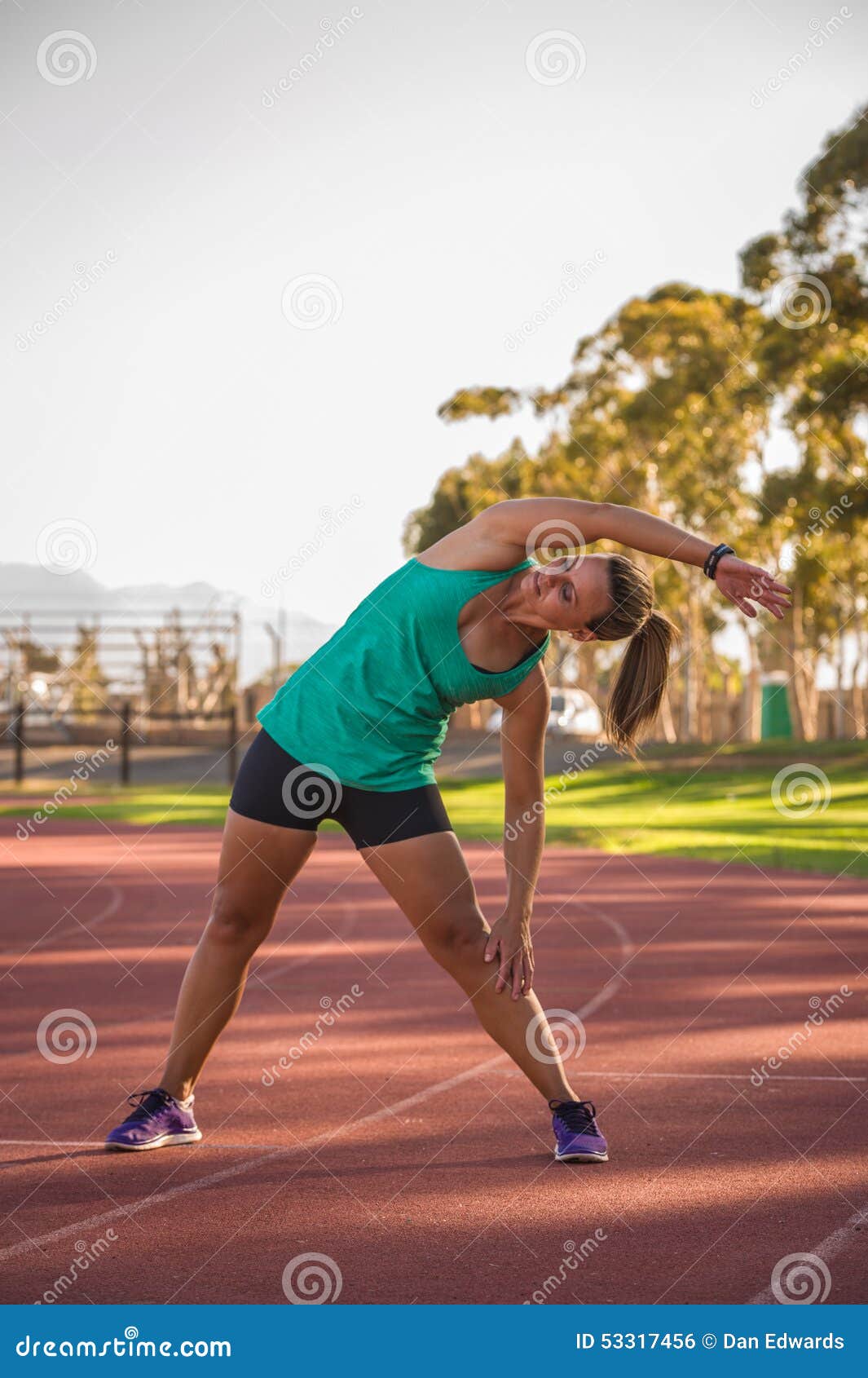 Female Athlete Stretching on a Running Track Stock Photo - Image of ...