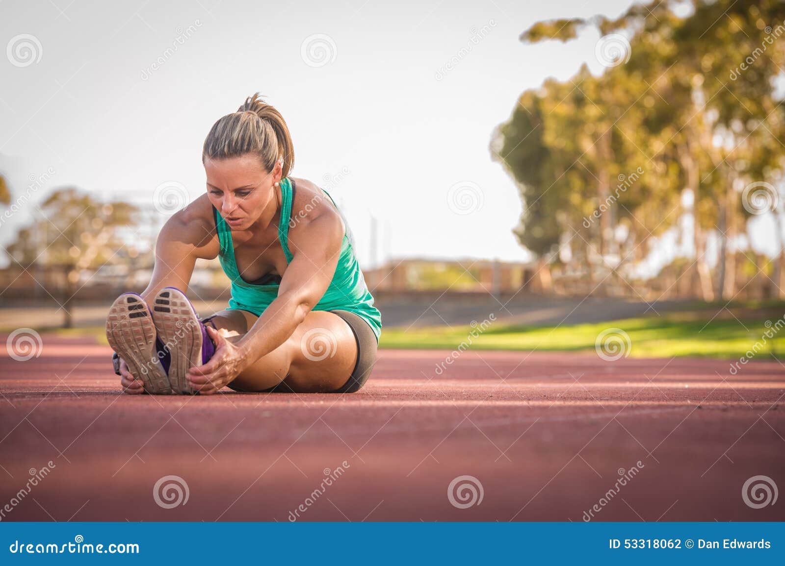 Female Athlete Stretching on a Running Track Stock Photo - Image of ...
