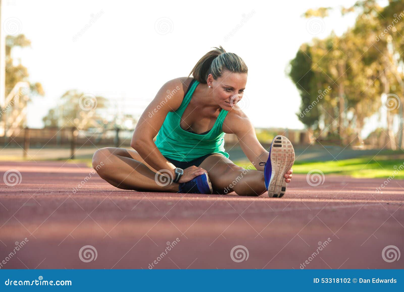 Female Athlete Stretching on a Running Track Stock Photo - Image of ...