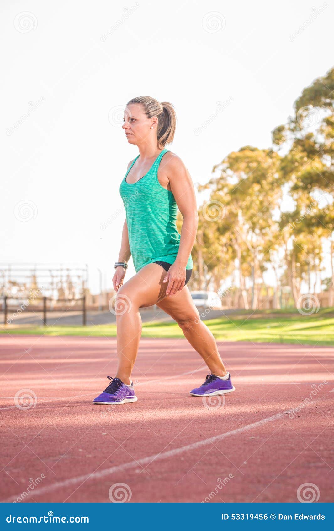 Female Athlete Stretching on a Running Track Stock Photo - Image of ...